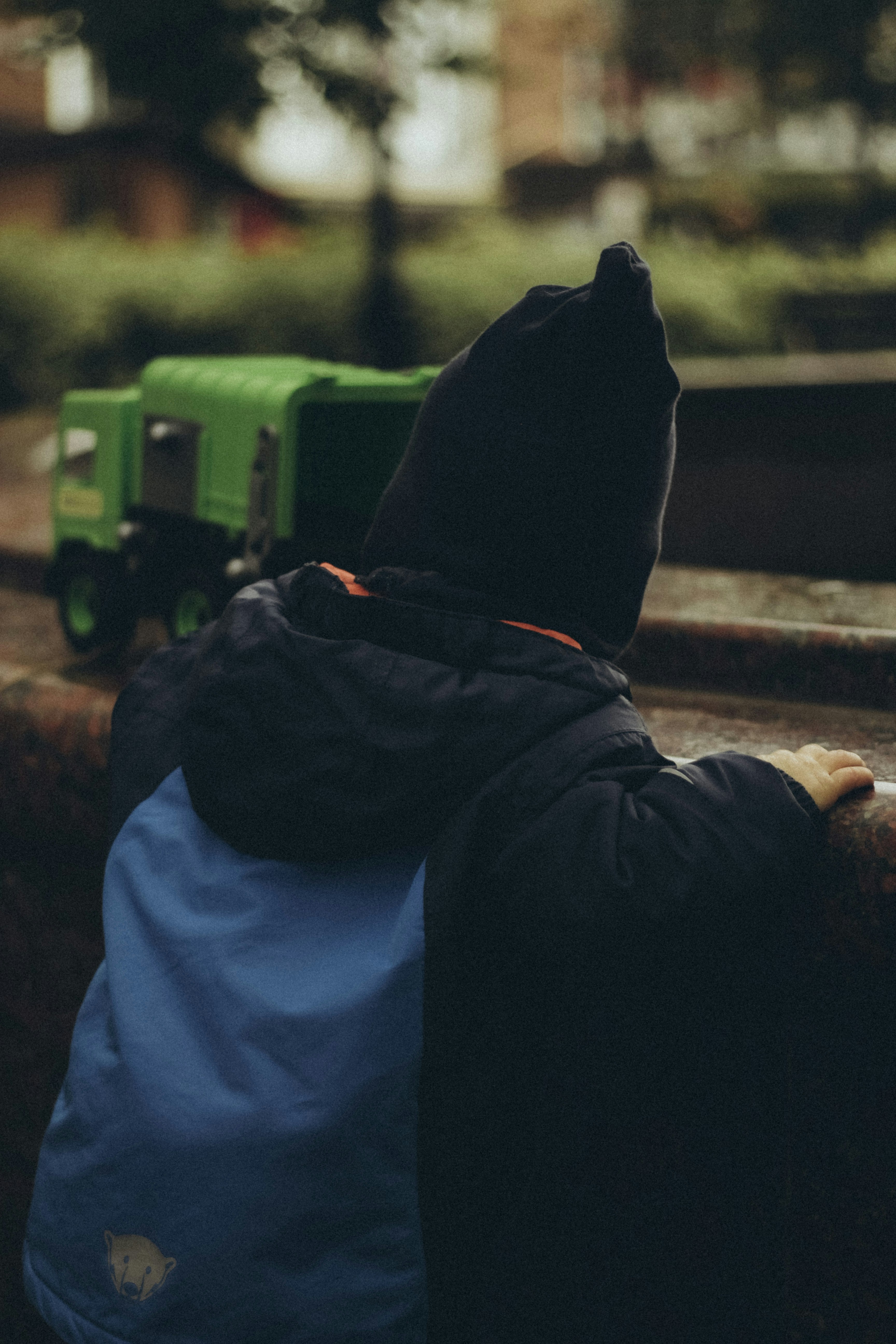 Curious Engine Watcher: A Child Peers Over a Railing