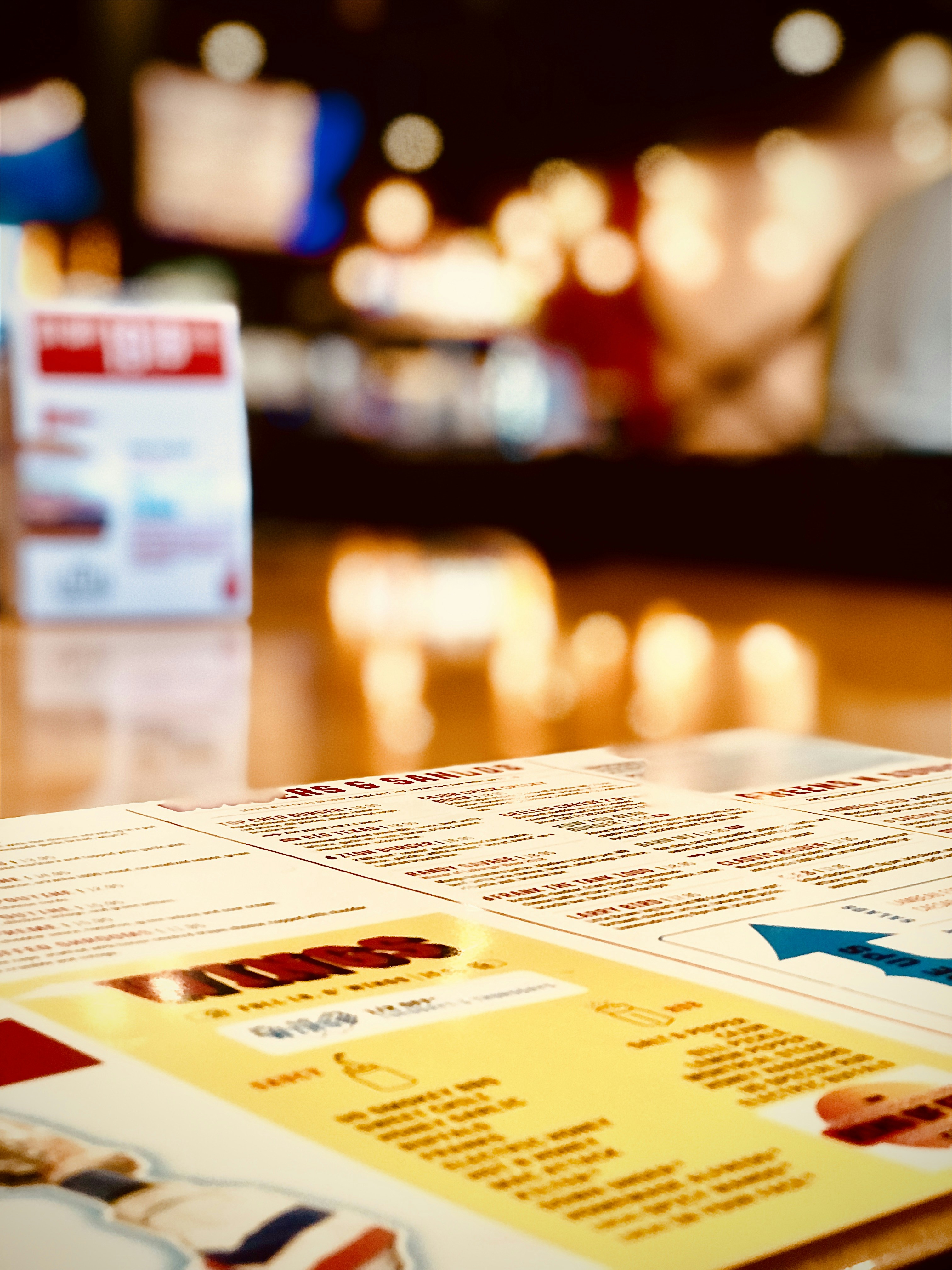 Blurred Bistro Beginnings: Colorful Menu Cards in a Quiet Café