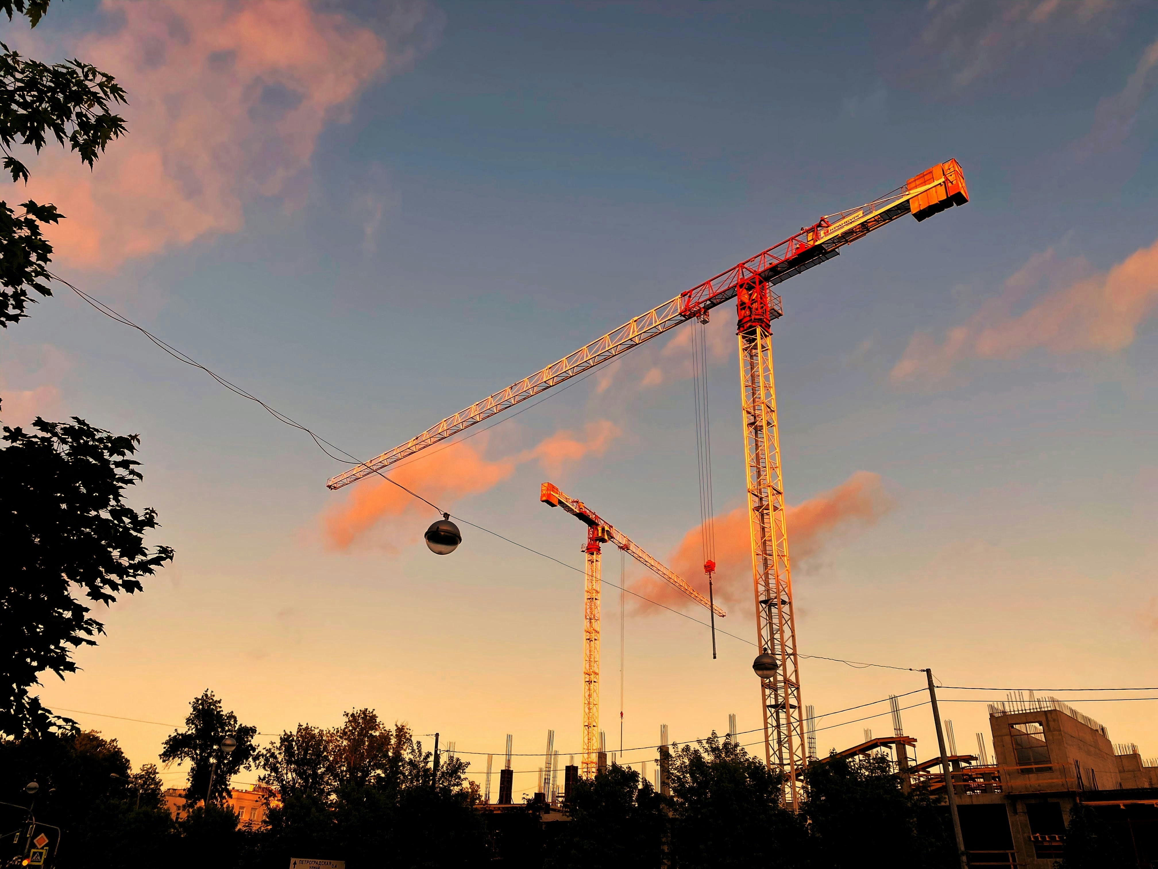 Twilight Cranes Over a Quiet Construction Yard