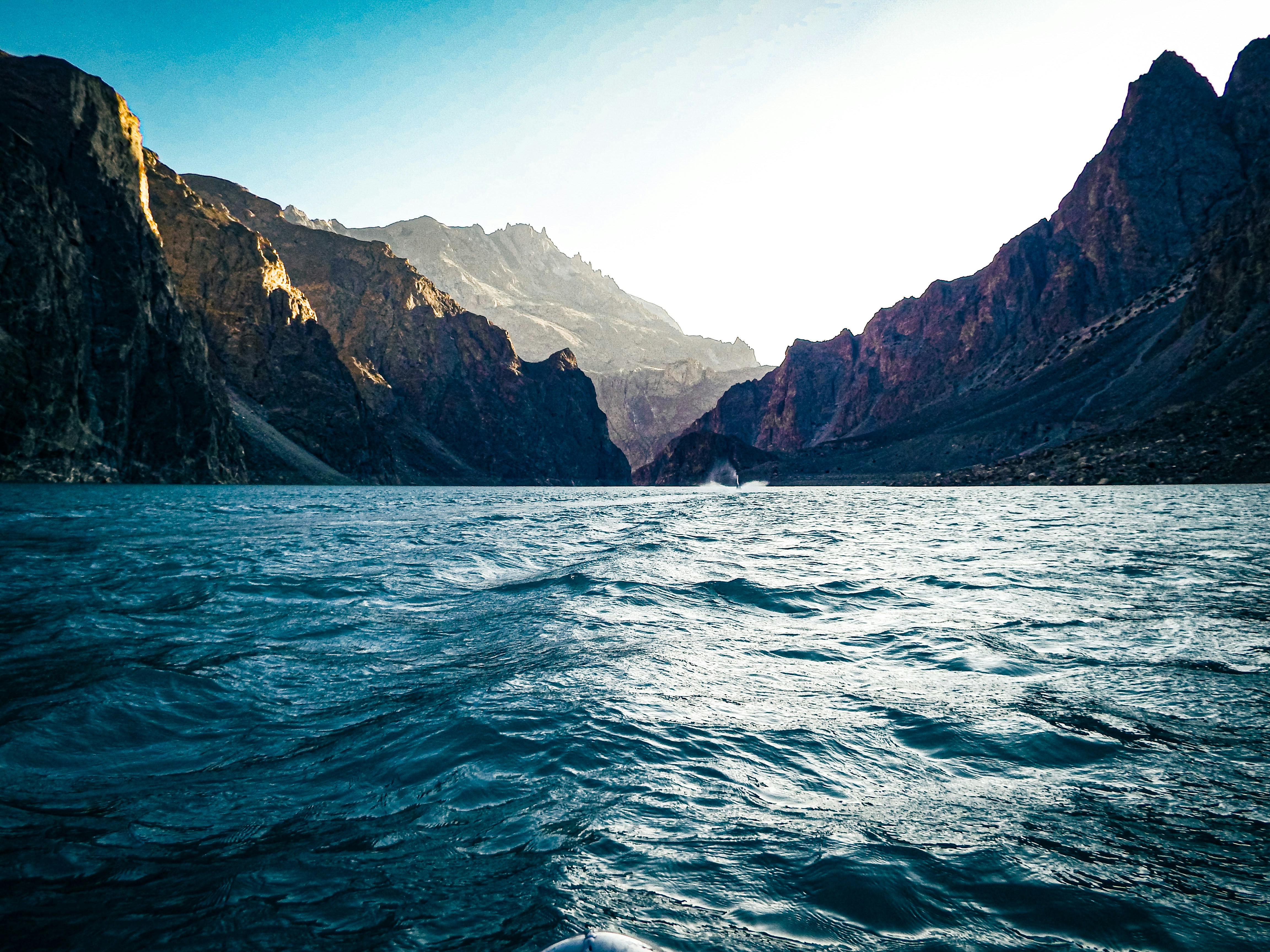 Rocky cliffs framing a tranquil sea with Tracy Arm in the background.