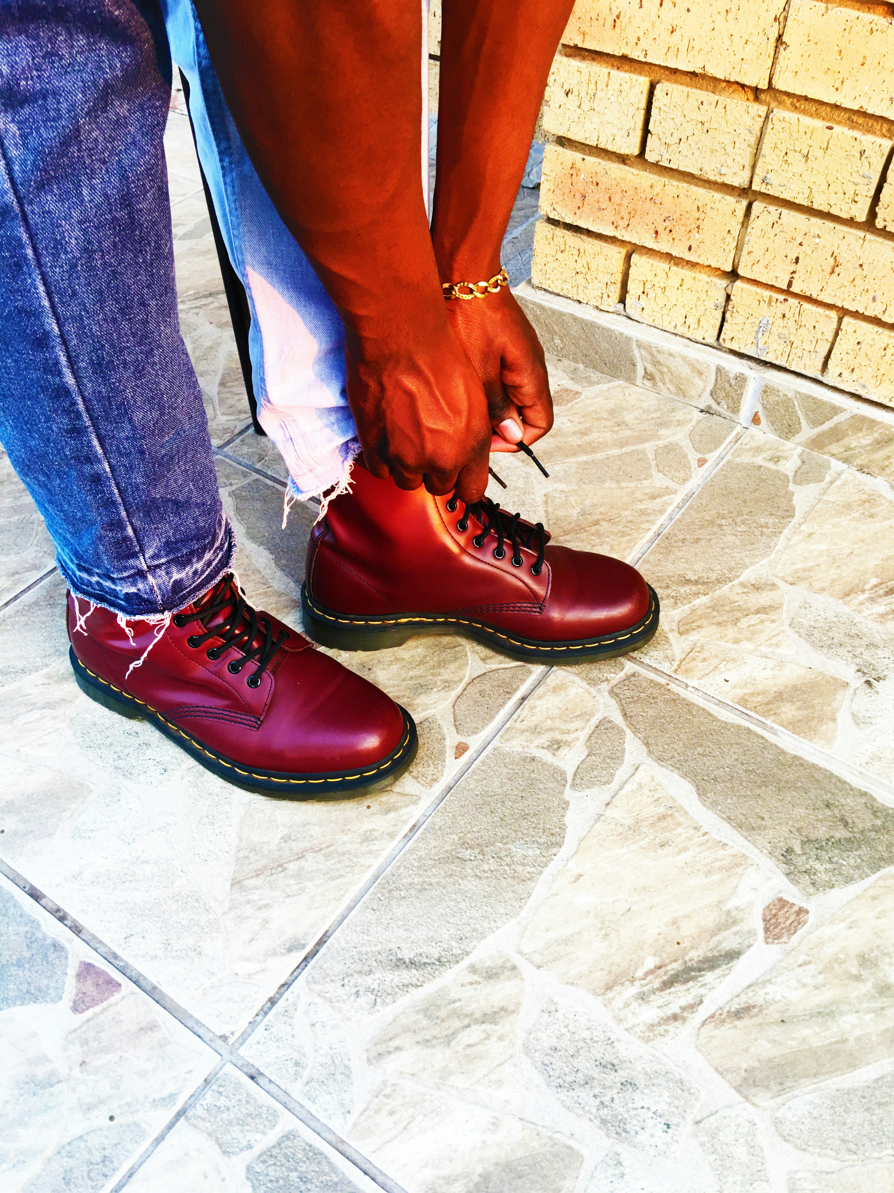 a person's feet wearing red shoes