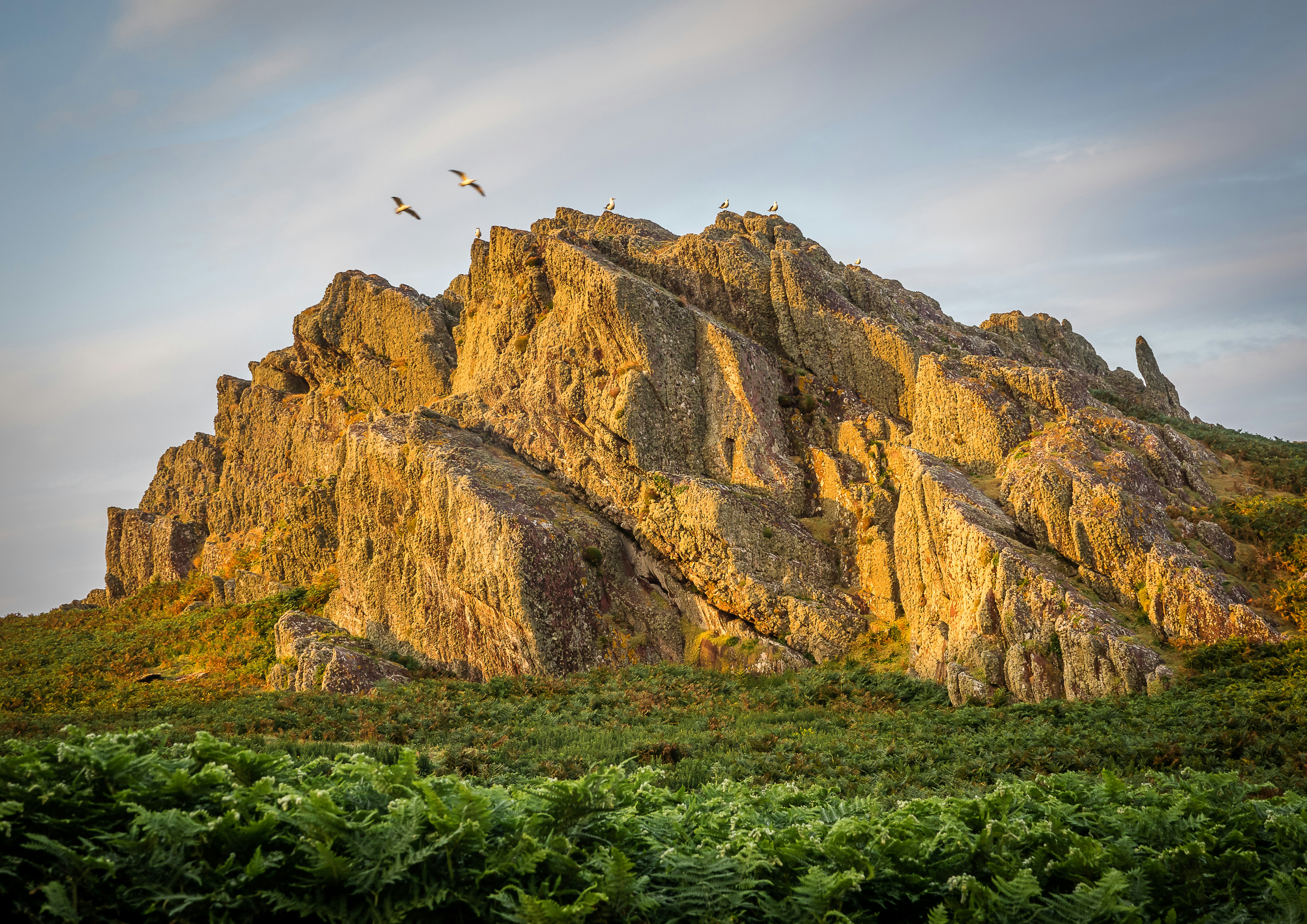 Sunlit Prominence: A Jagged Cliff Crowned by Golden Light