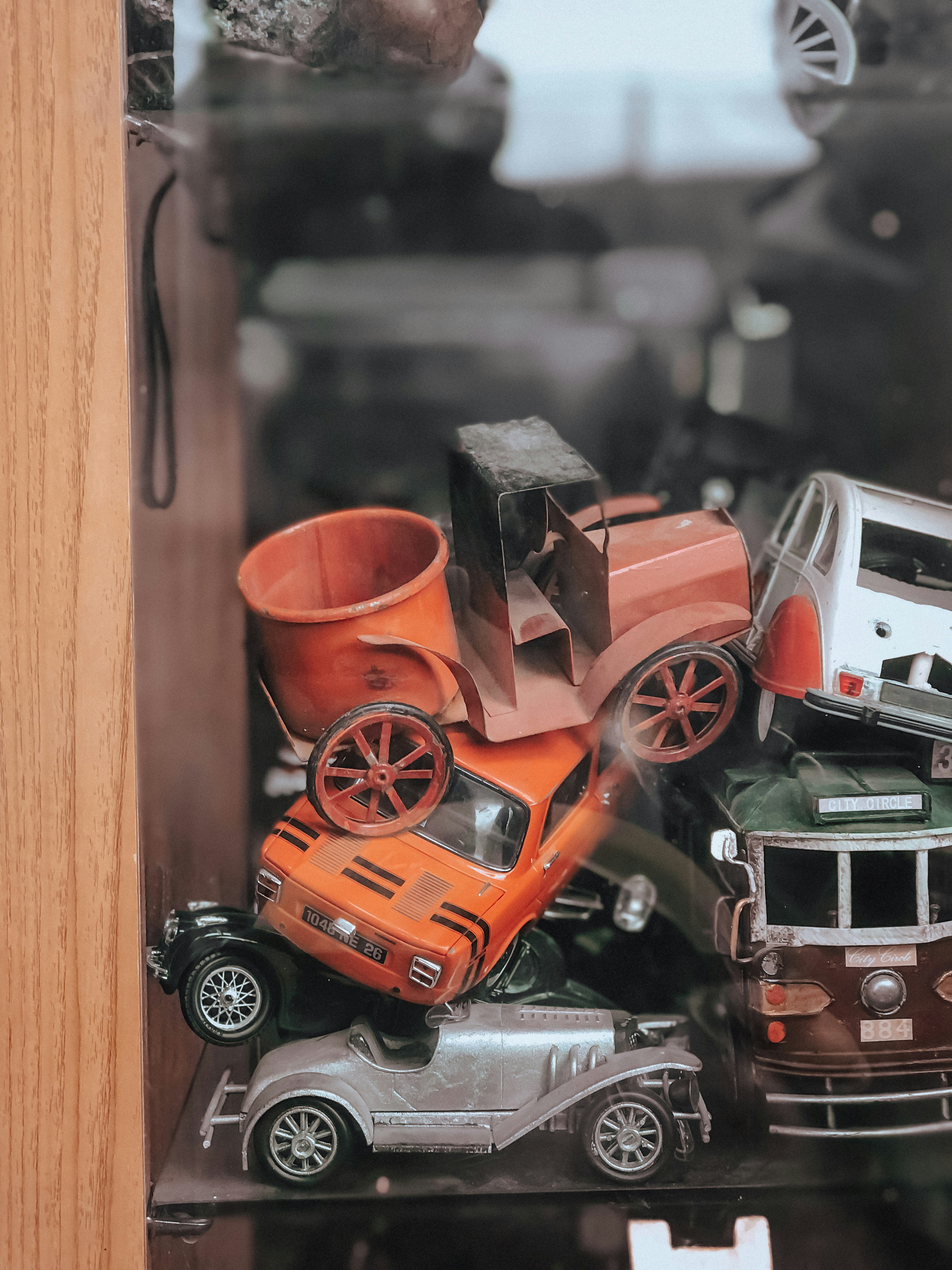 Toy convoy under glass: vintage vehicles suspended in a tiny world