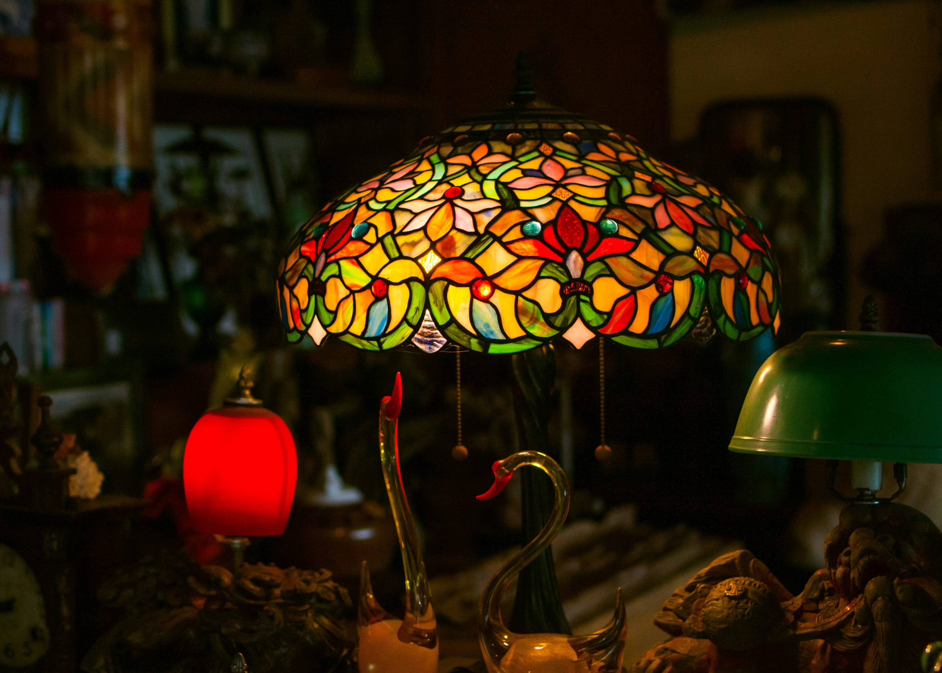 Tiffany in Twilight: Warm Mosaic over a Shelf of Oddities