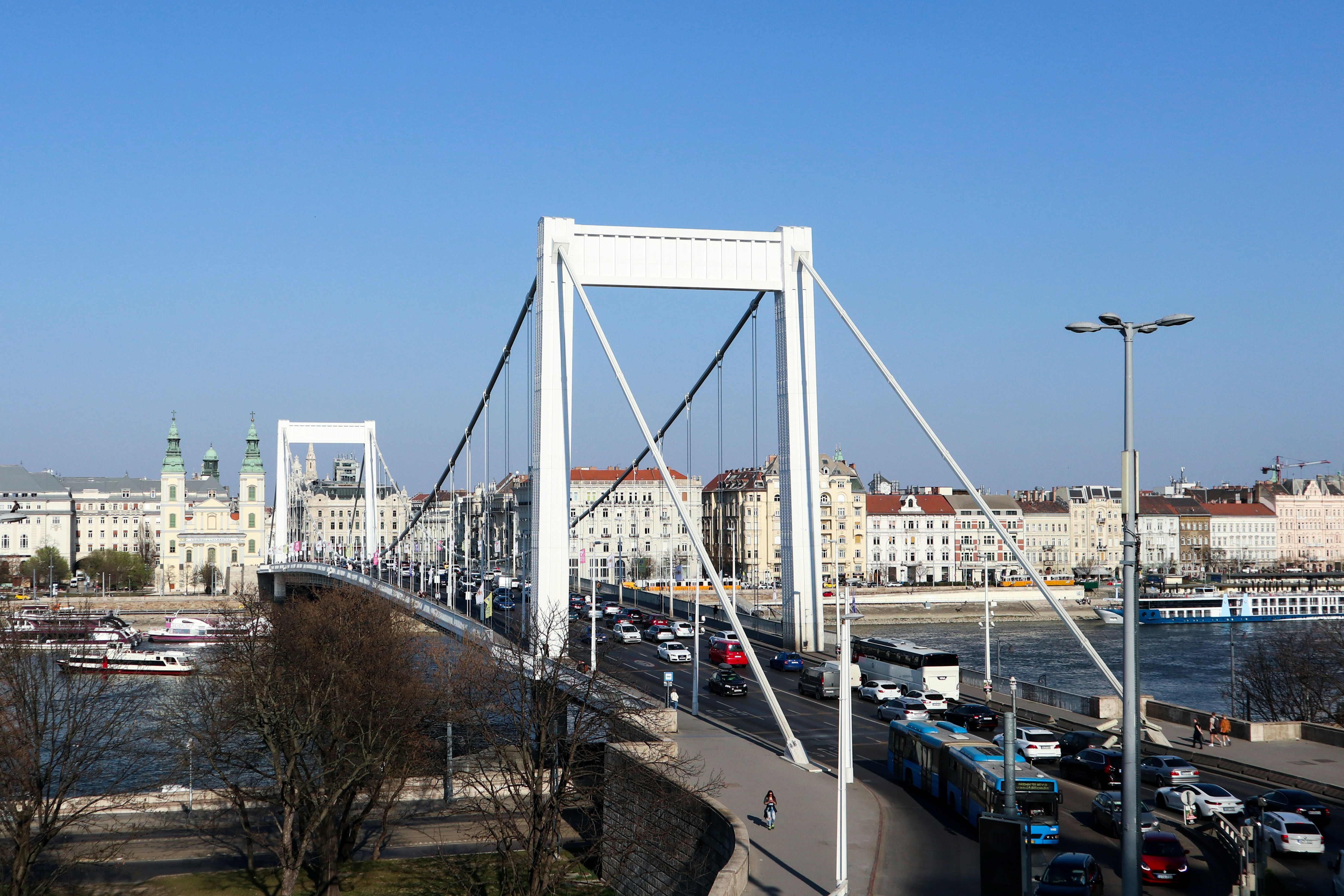  cables to the city: a white suspension bridge crossing the river