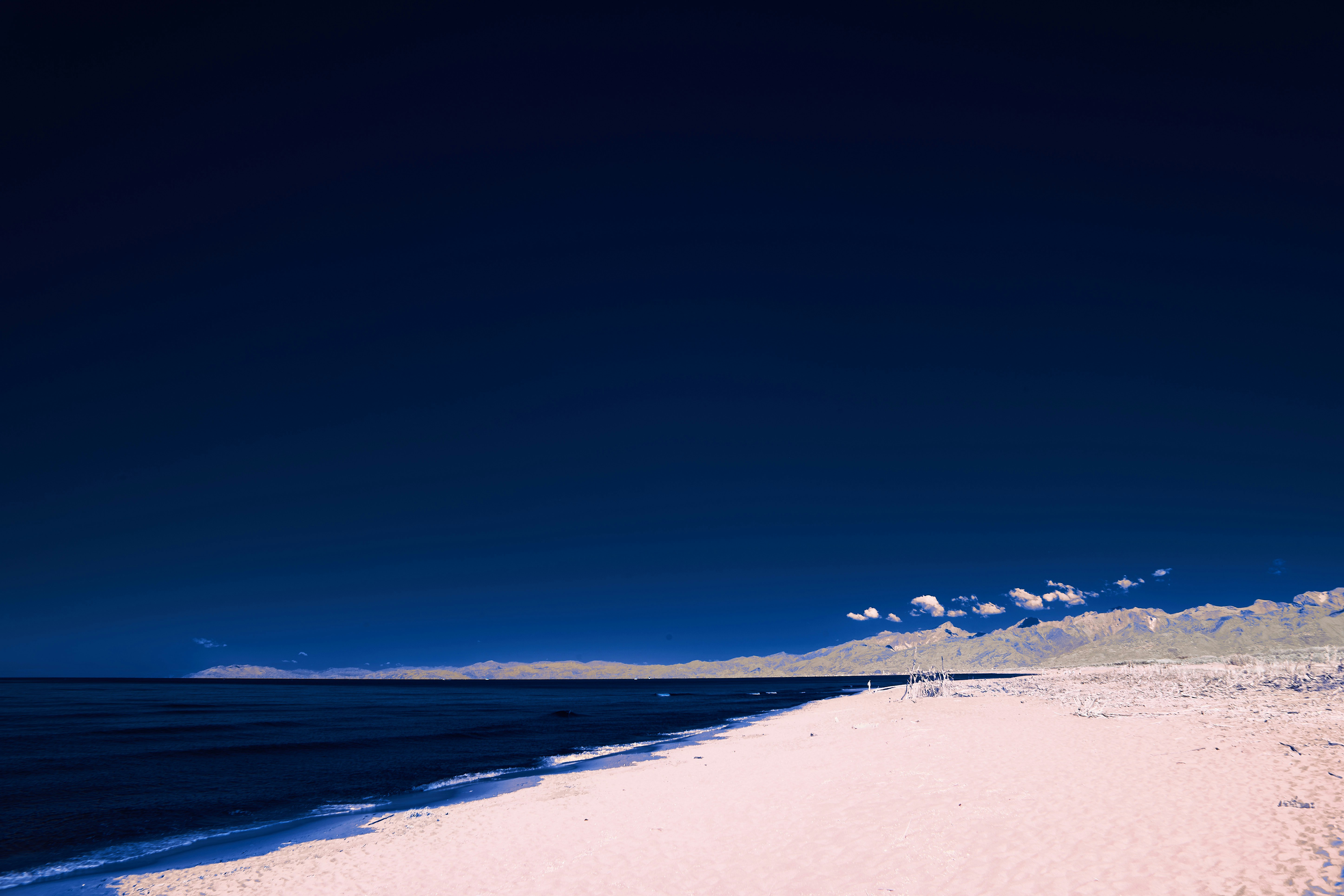 Nocturne at the Coast: Deep Indigo Sky and Bleached Shore