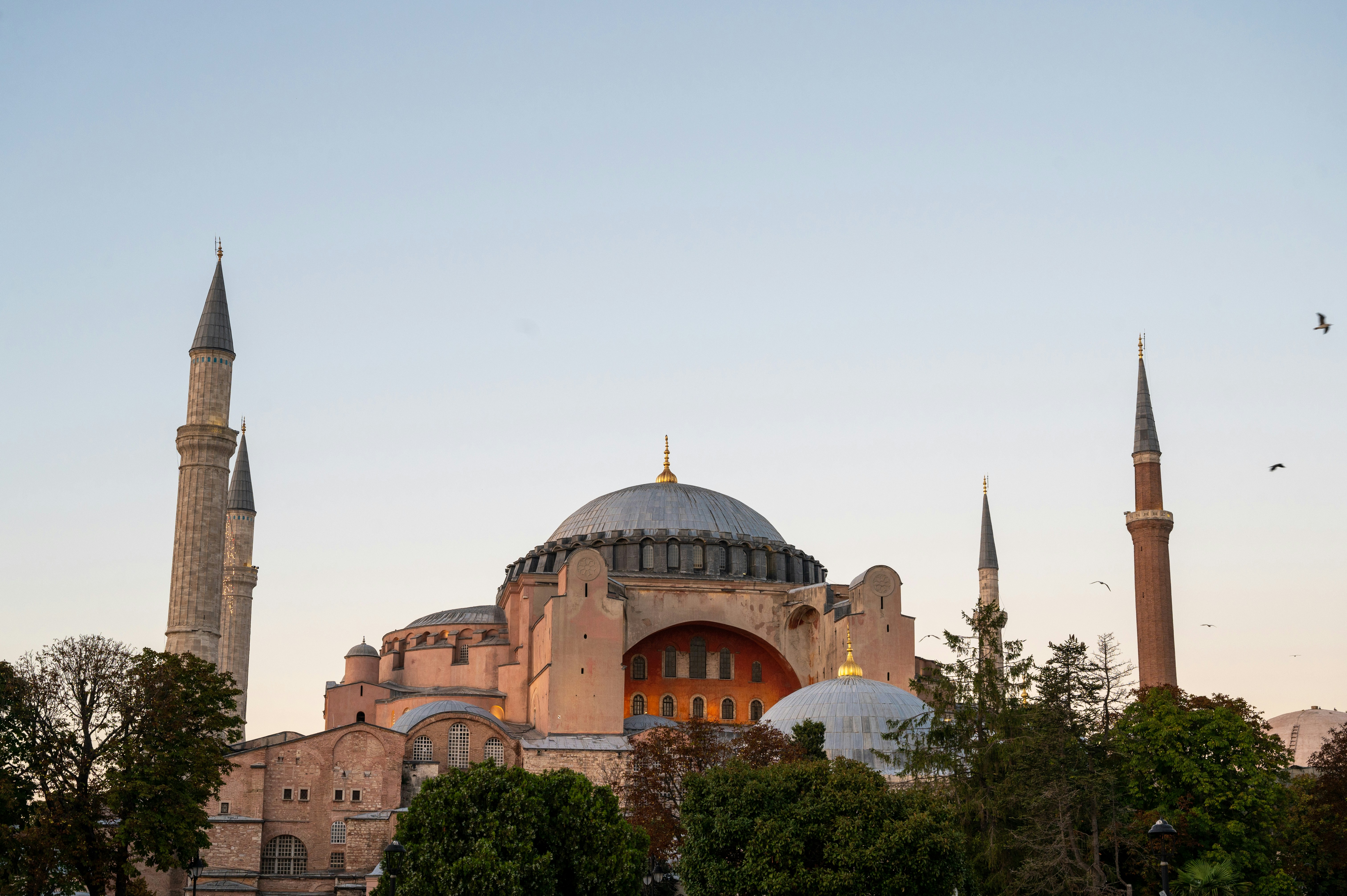 A large building with towers with Hagia Sophia in the background photo ...