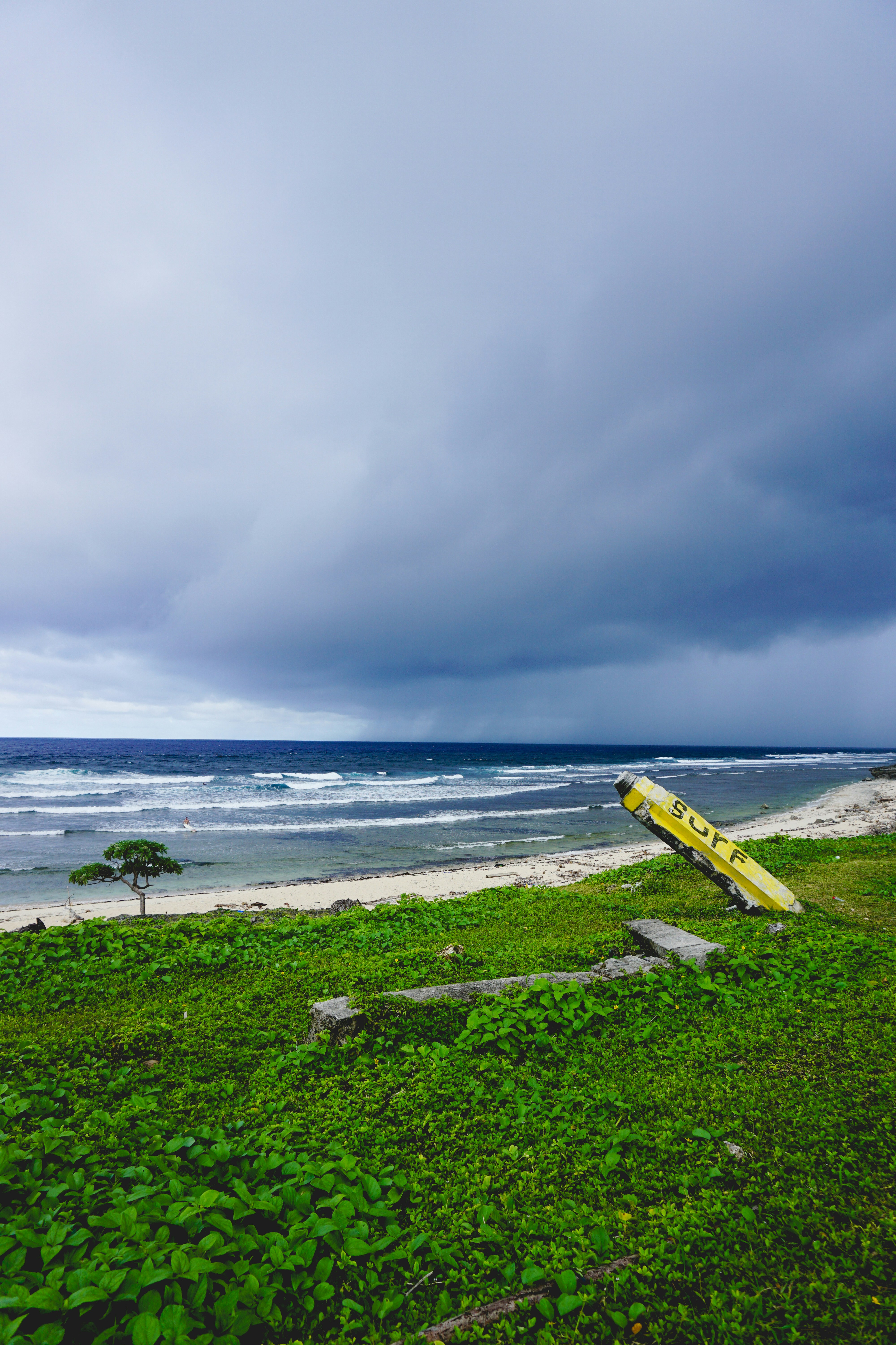 A yellow surfboard on a beach photo – Free Calicoan island Image on ...