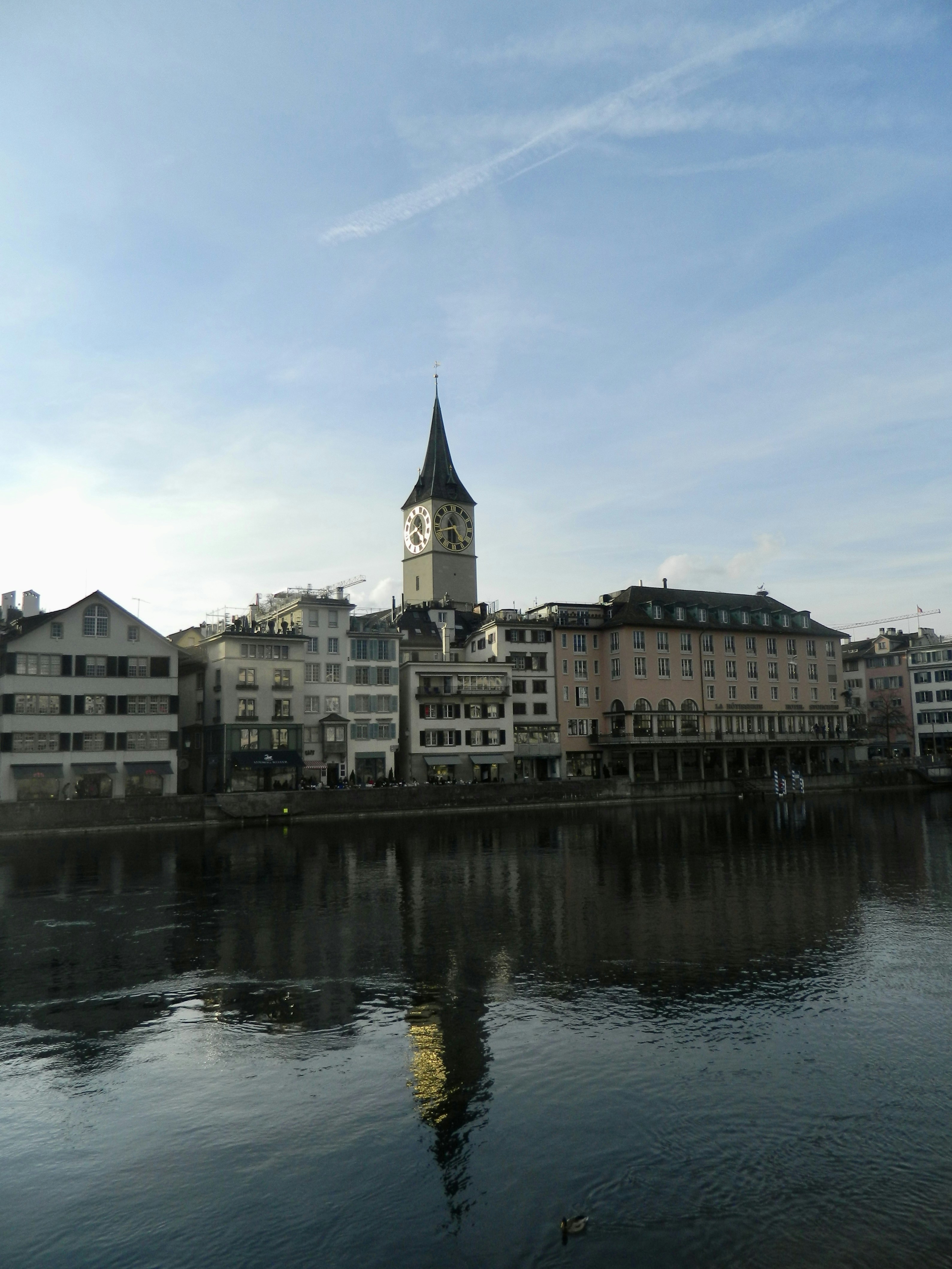 Clock Tower by the River: Reflections in a European Waterfront Quarter