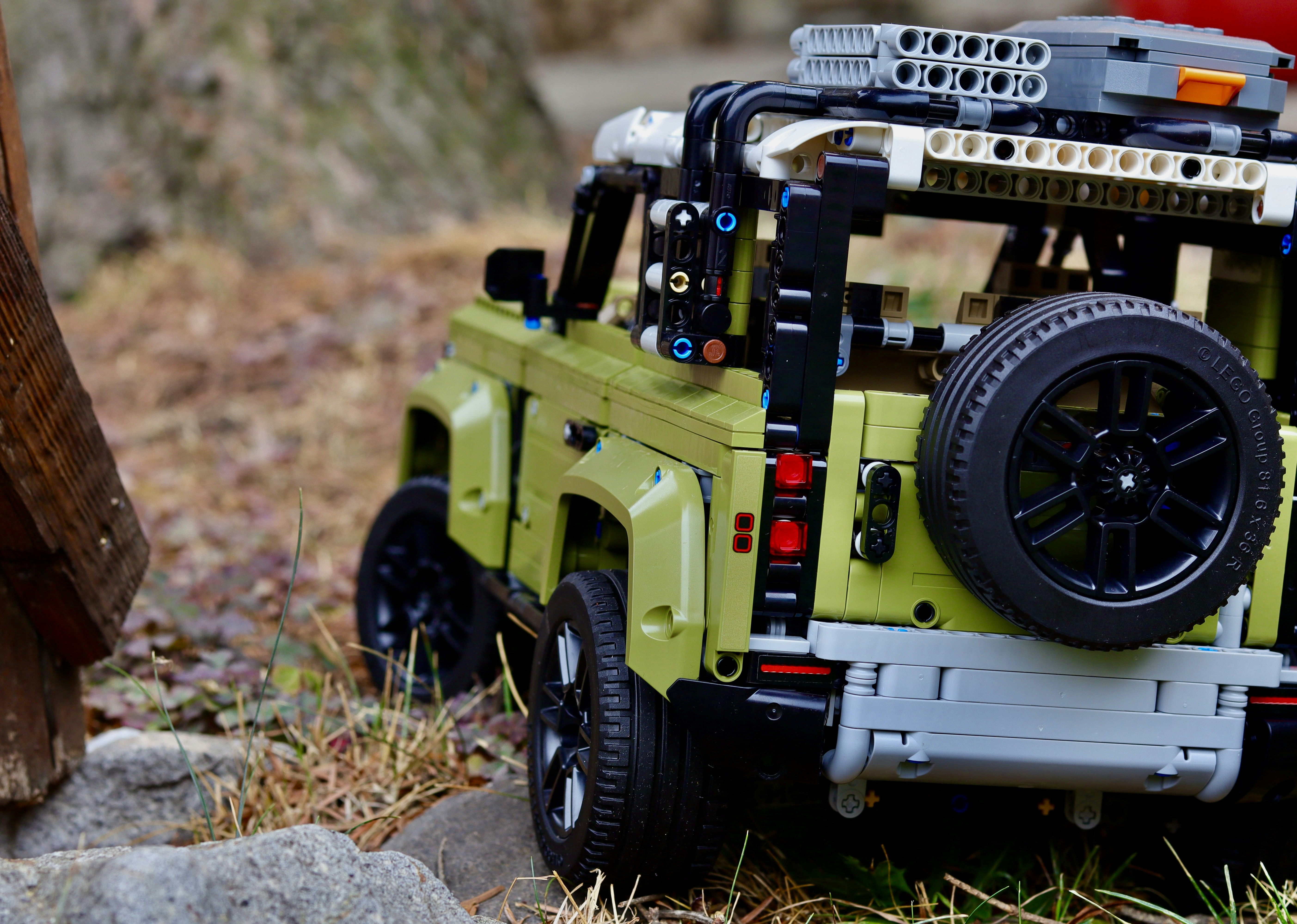 Olive LEGO Defender: A Tiny Off-Roader on a Pebble Ridge