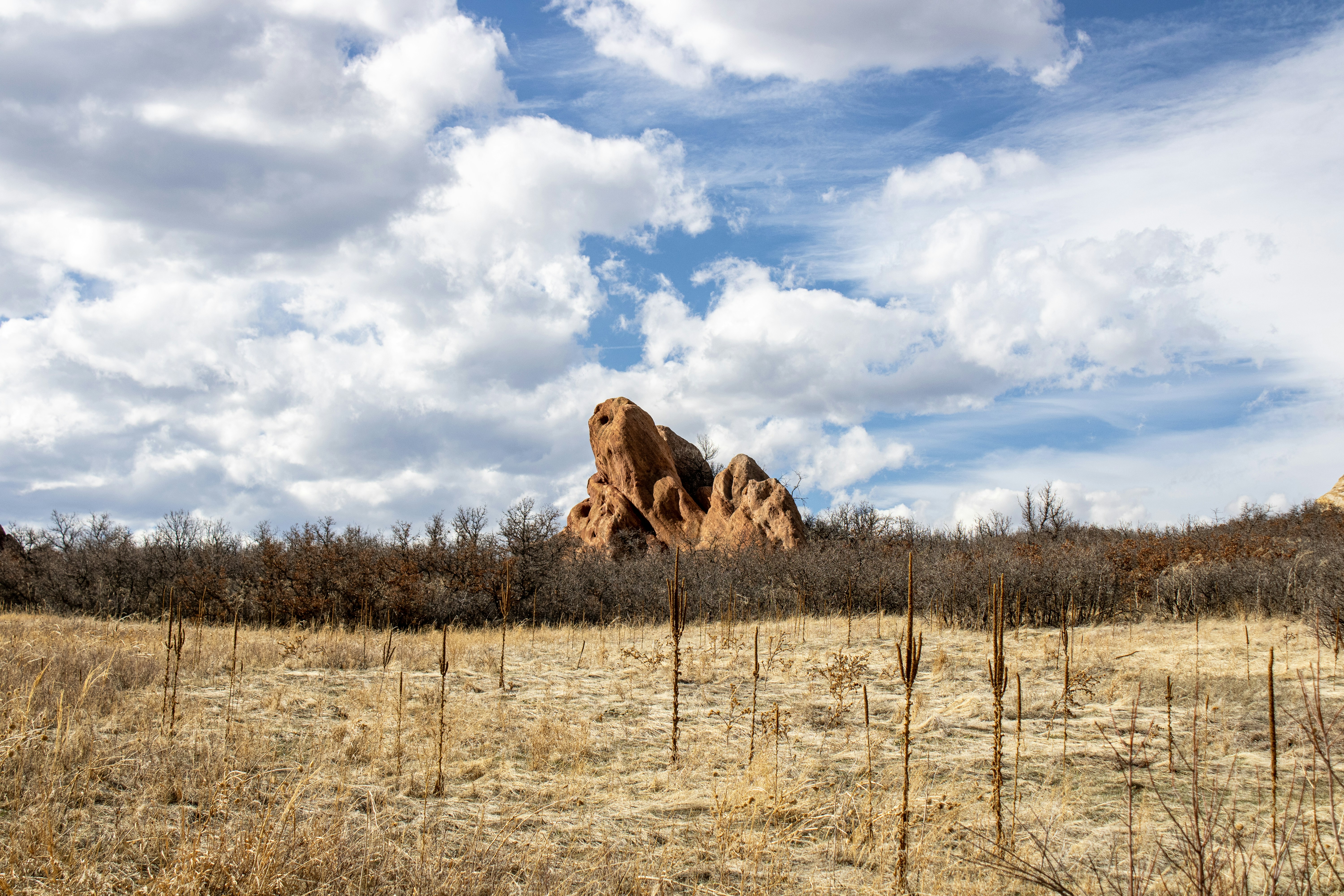 Granite Guardian Rising Over a Dry Prairie