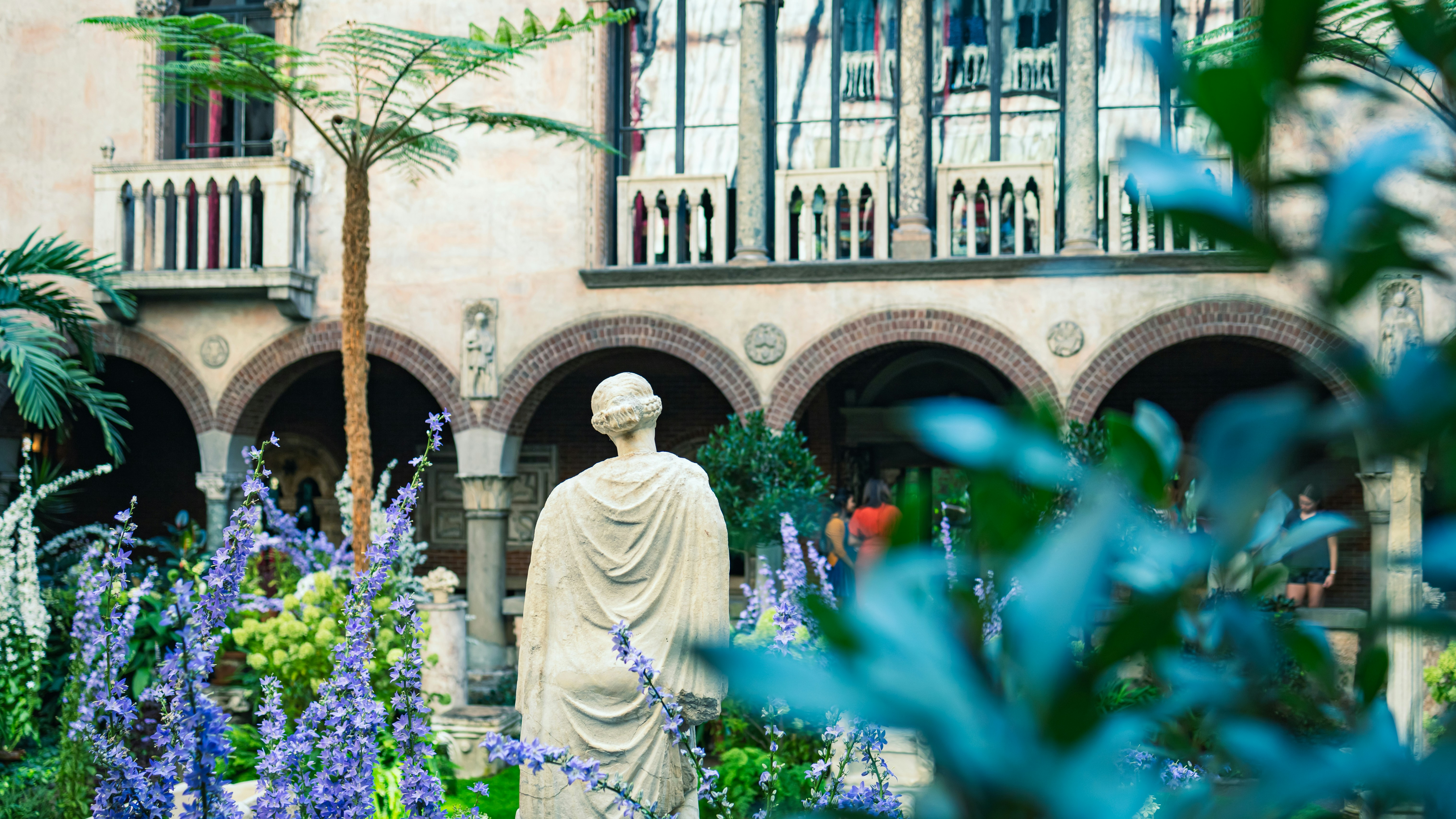 Statue in the Cloister Garden: Archways and Blooms