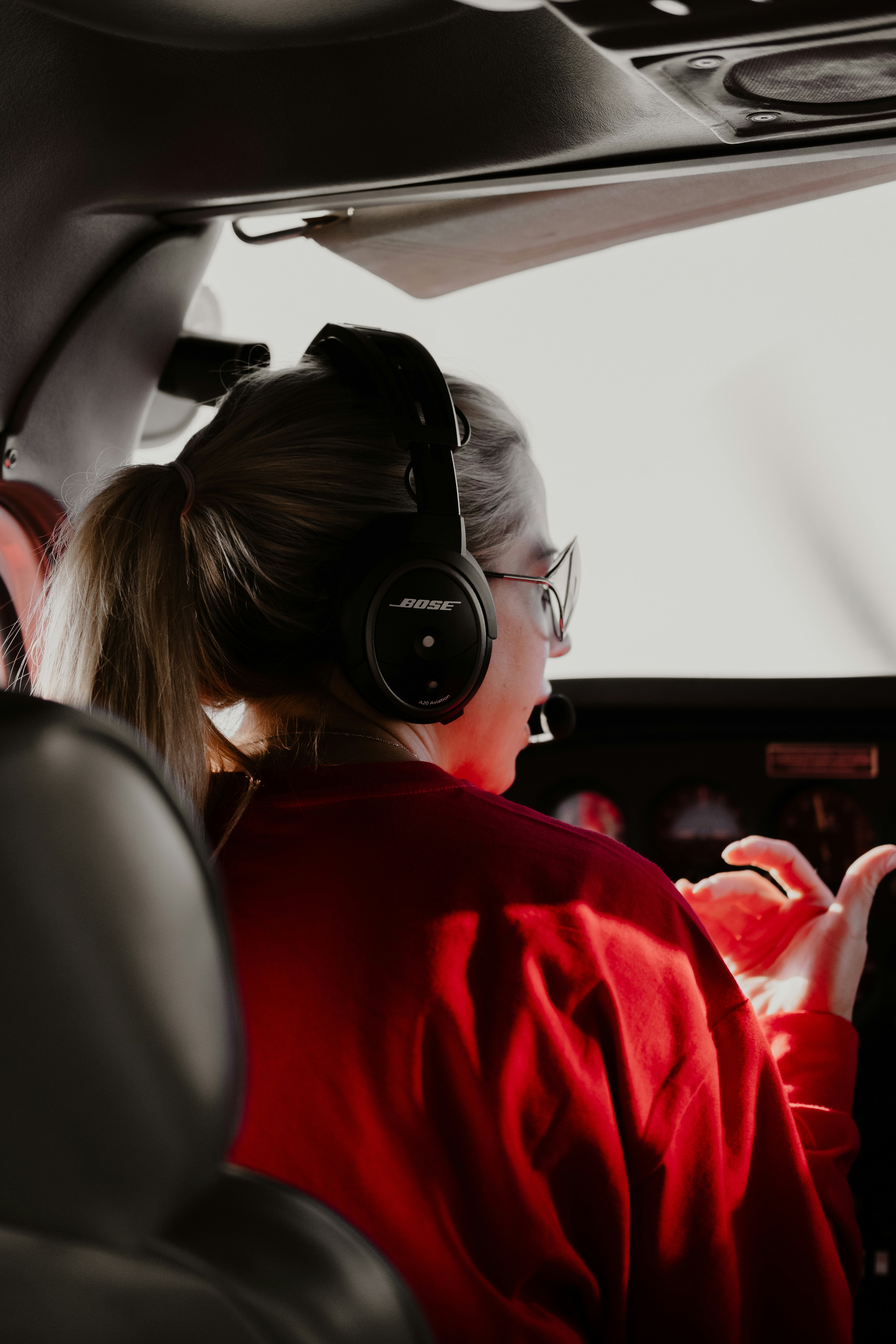 Headseted Focus: Inside the Cockpit with a Pilot in Red
