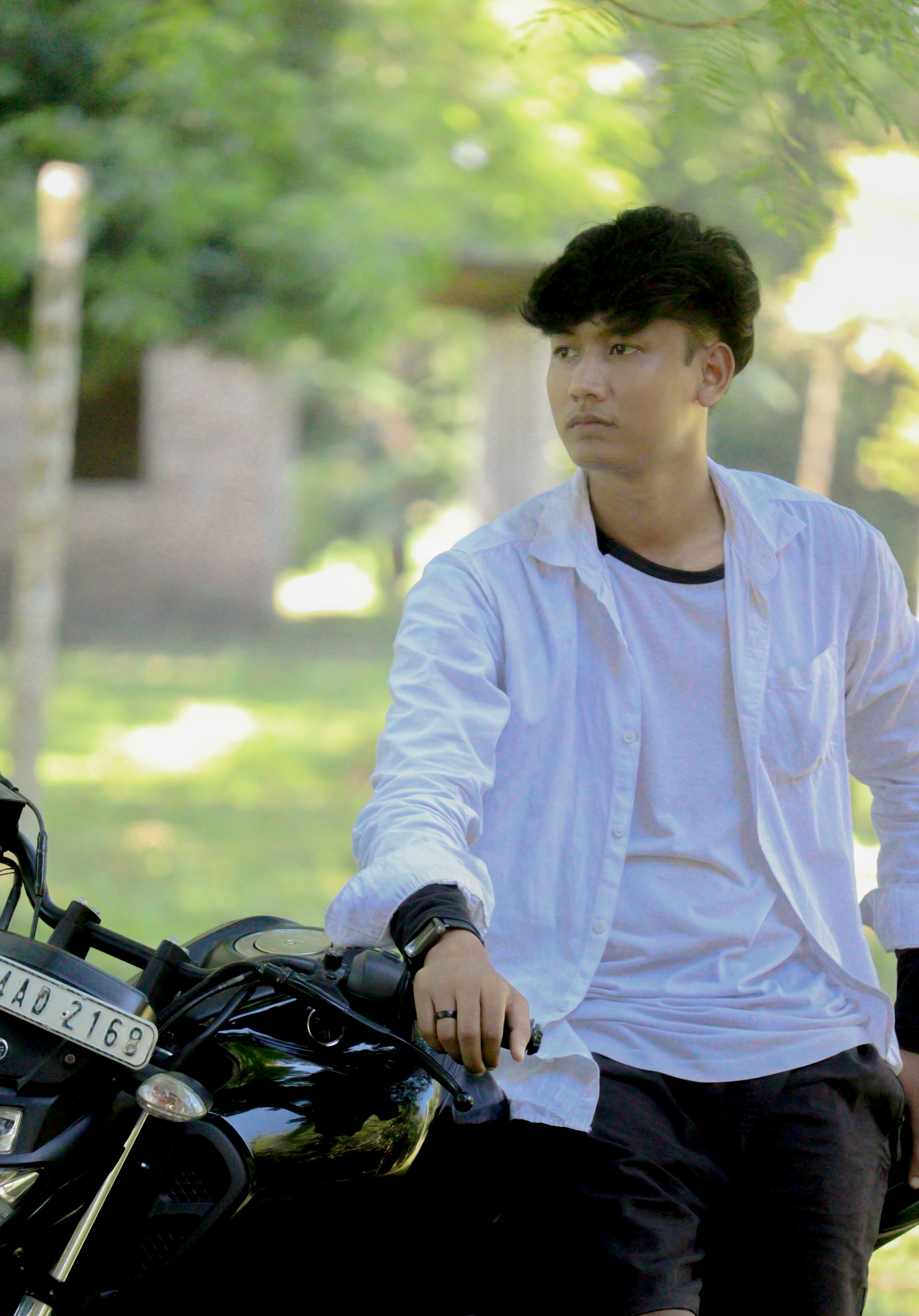 A man sitting on a motorcycle photo – Free Handsome assamese man Image ...