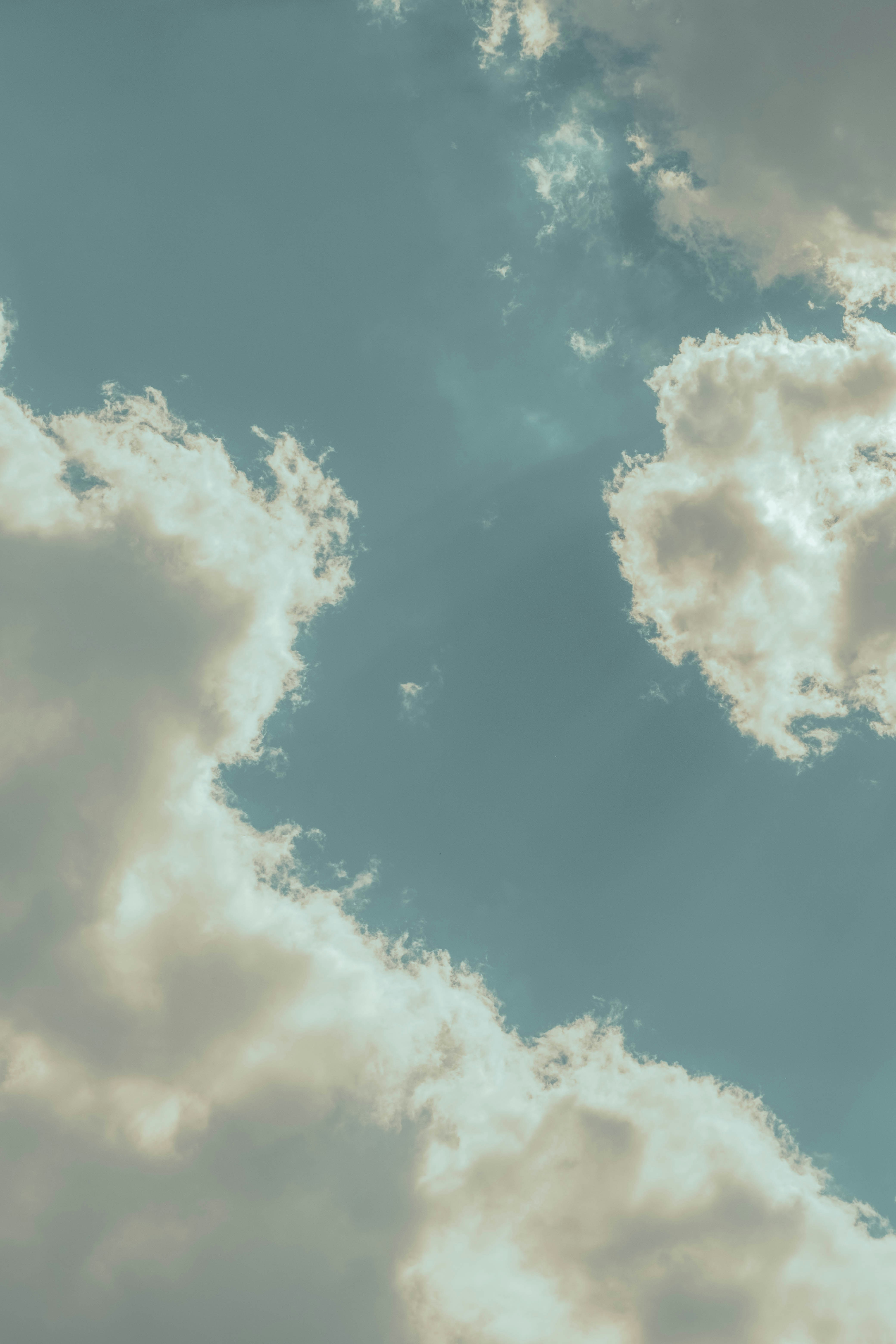 Azure Edges: Sunlit Cloudlets Across a Quiet Sky