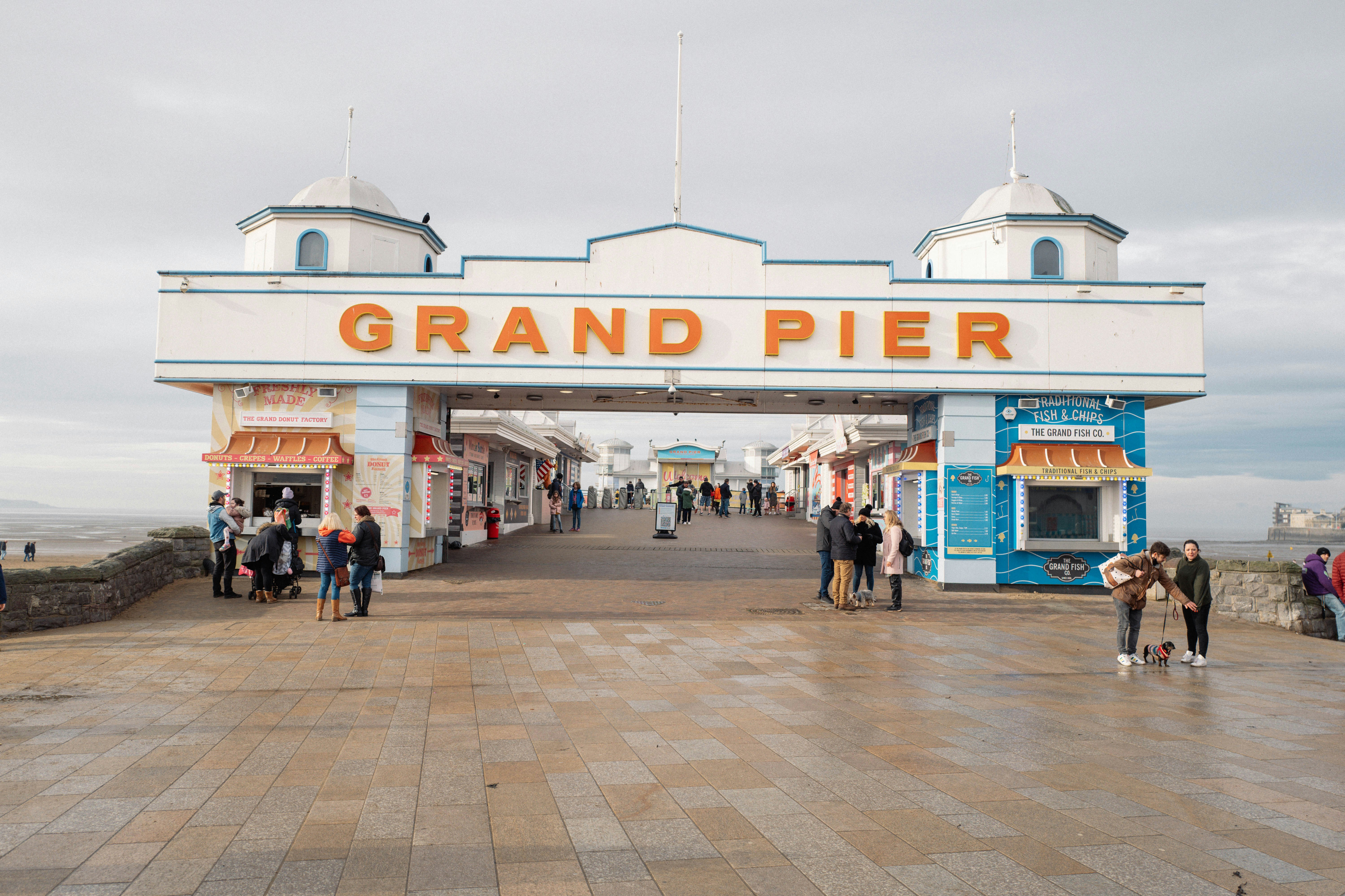 A group of people outside of a building photo – Free British beach ...