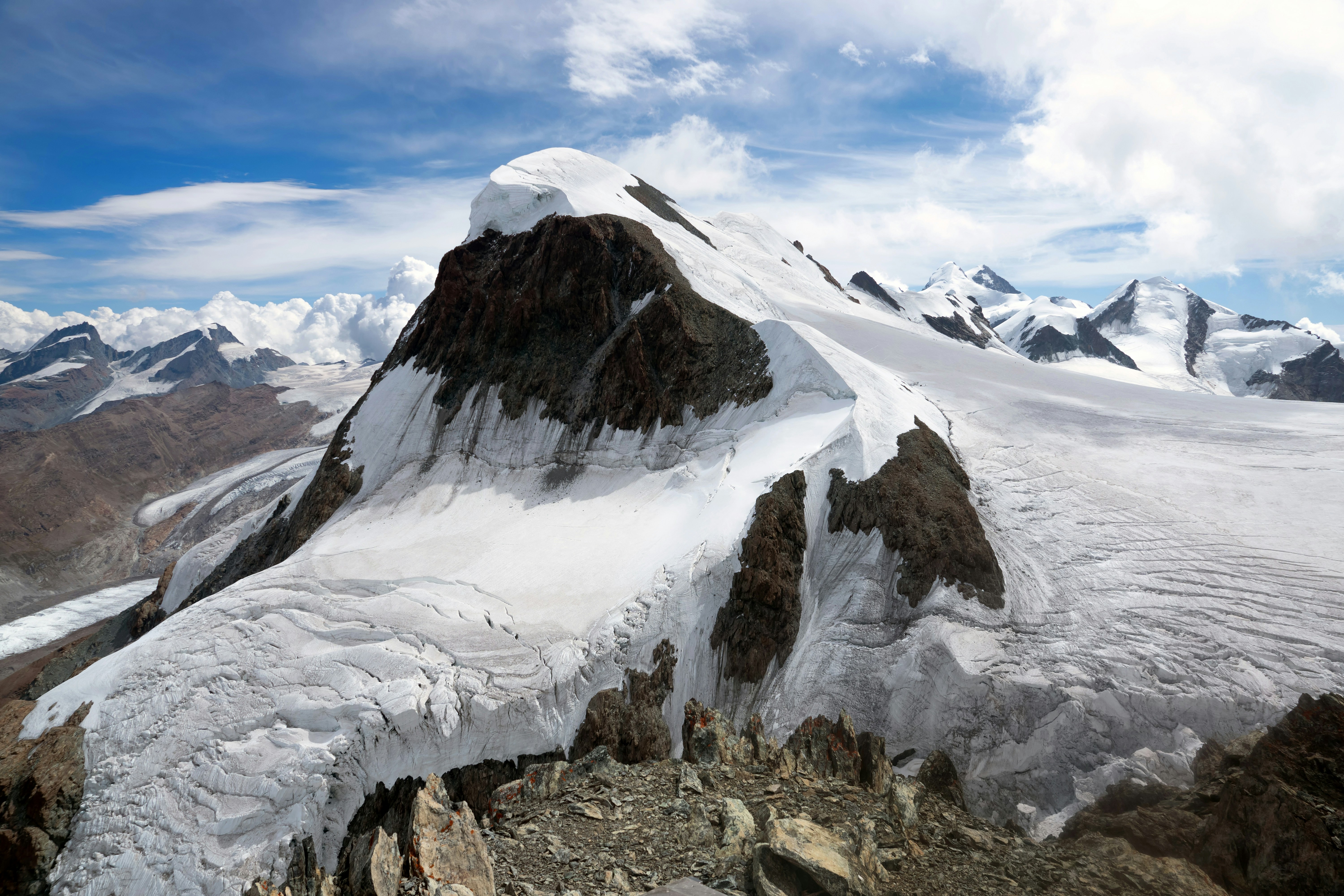 A snowy mountain with a valley below photo – Free Swiss alps Image on ...