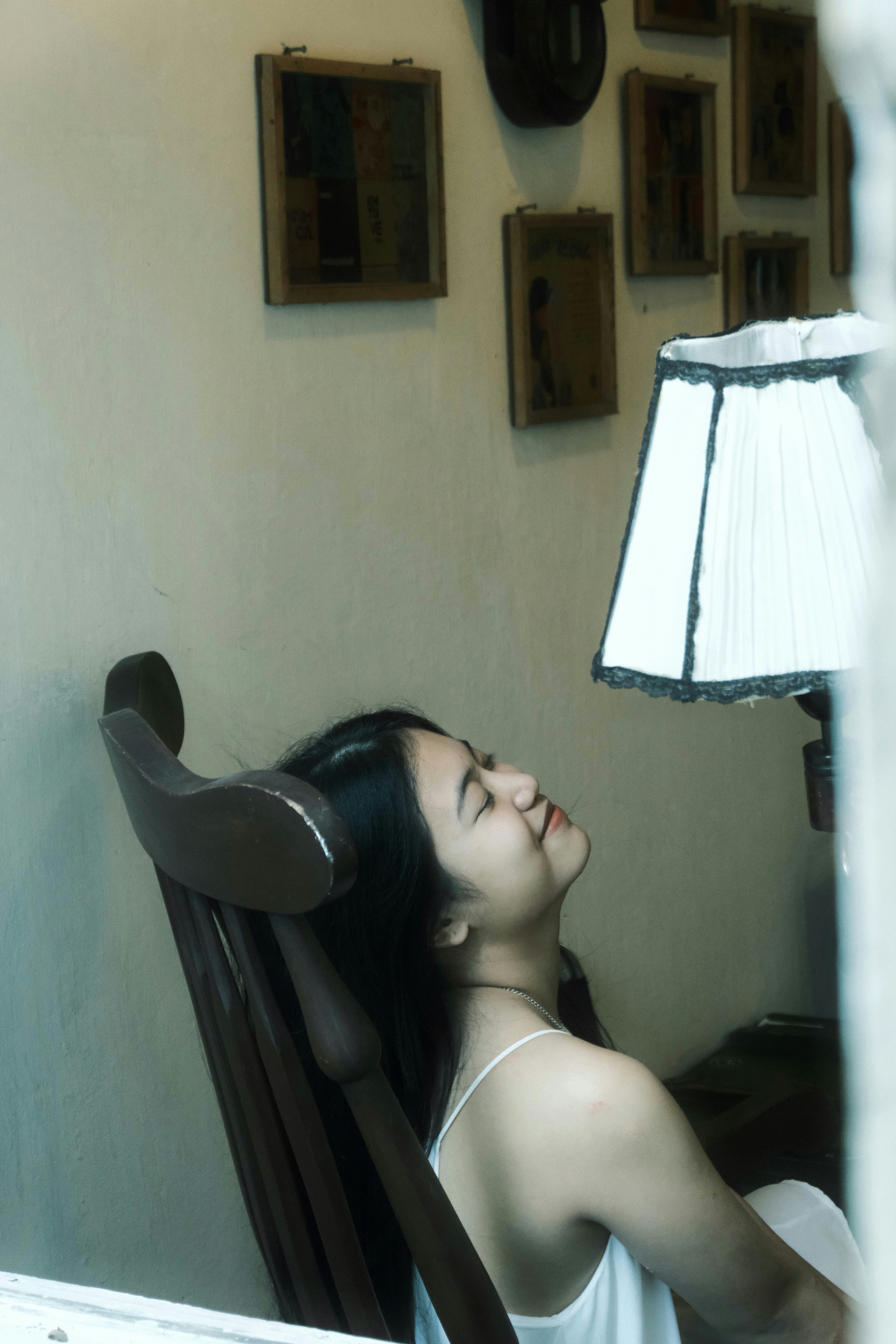 Lampshade Reverie: A Quiet Portrait in a Wooden Lounge