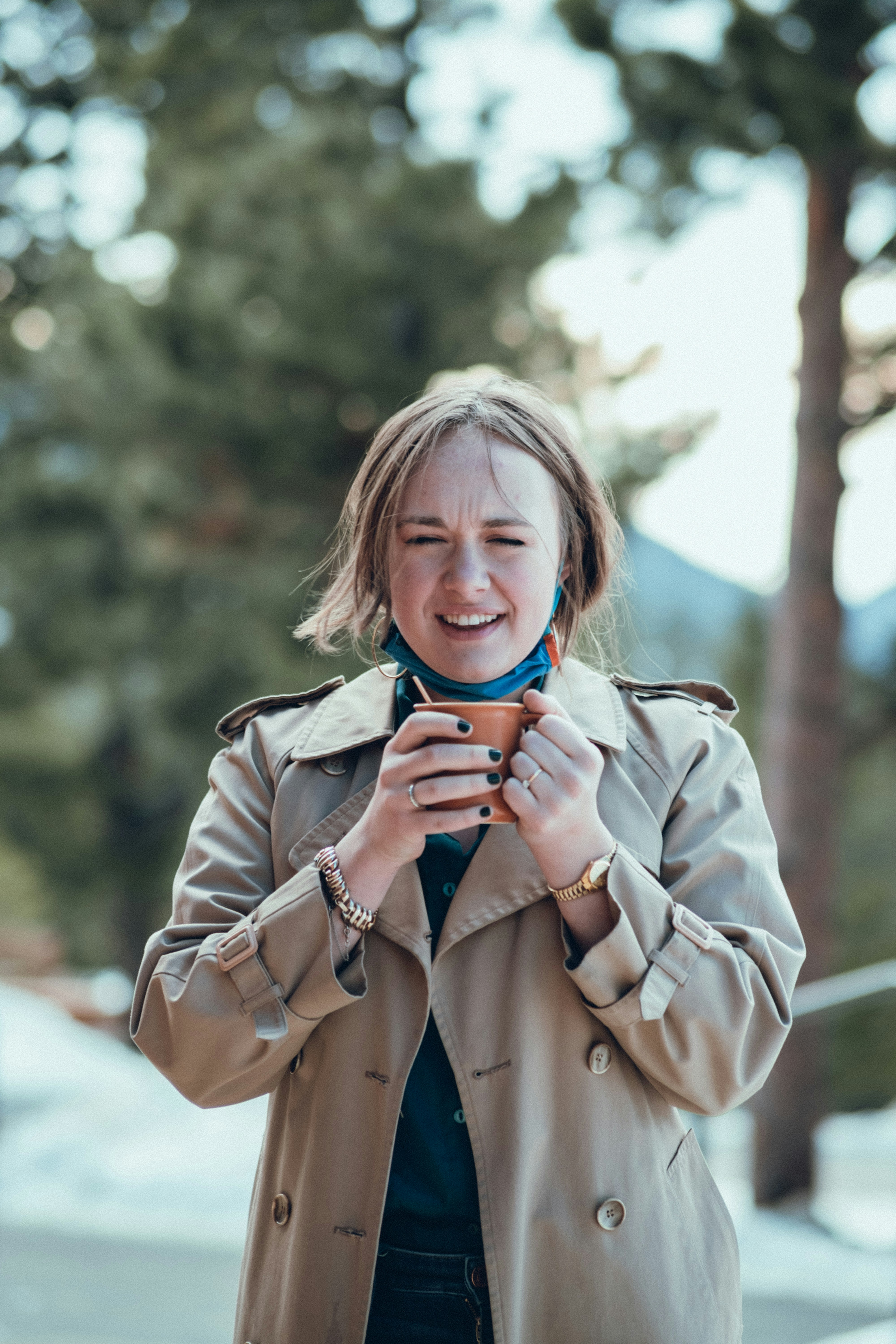 Warm Café Moment: A Woman With A Cup Amid Rustic Outdoors