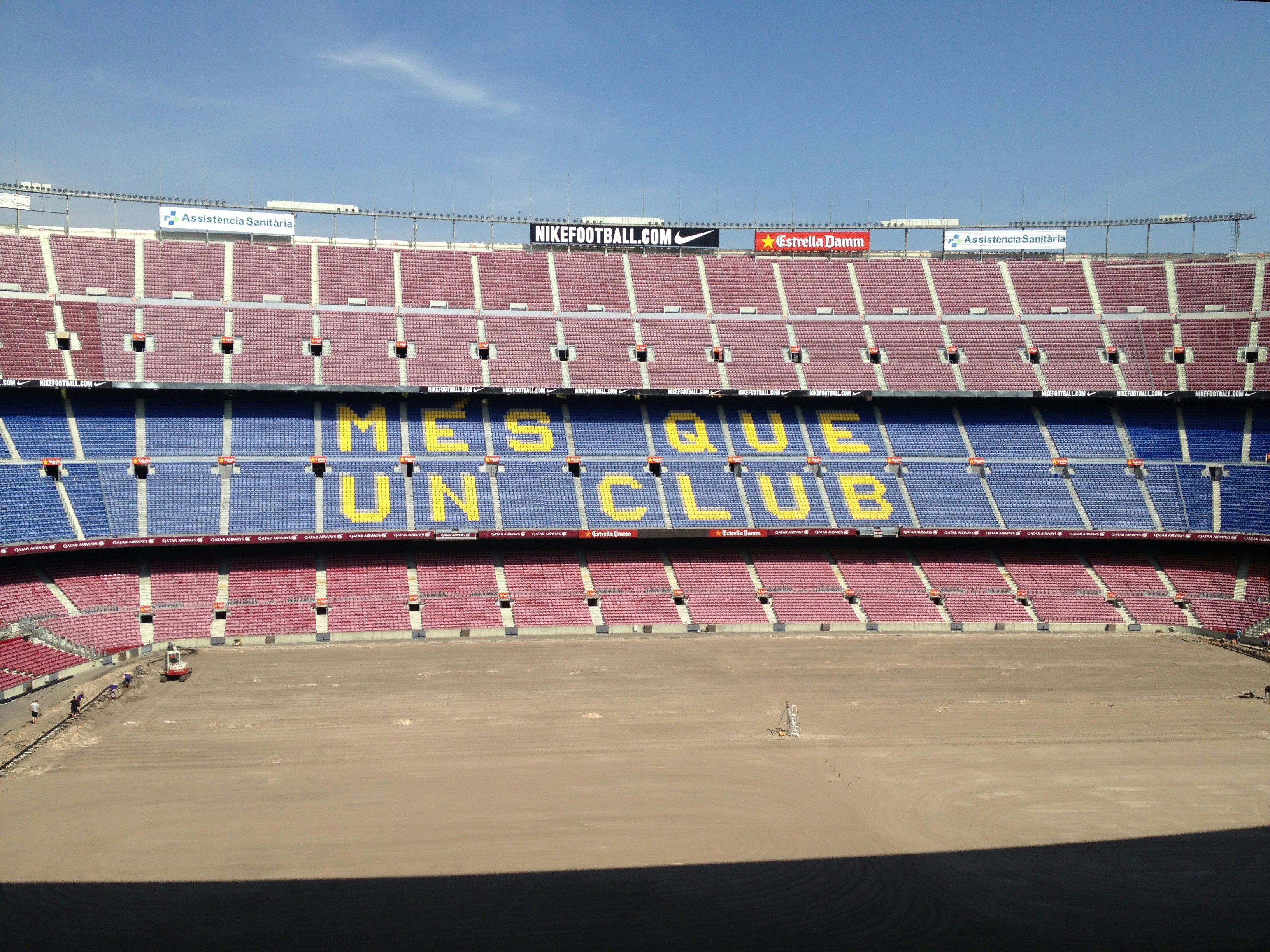 The iconic phrase 'Més que un club' is boldly displayed in the stands of a football stadium, highlighting the profound connection between the team and its supporters.