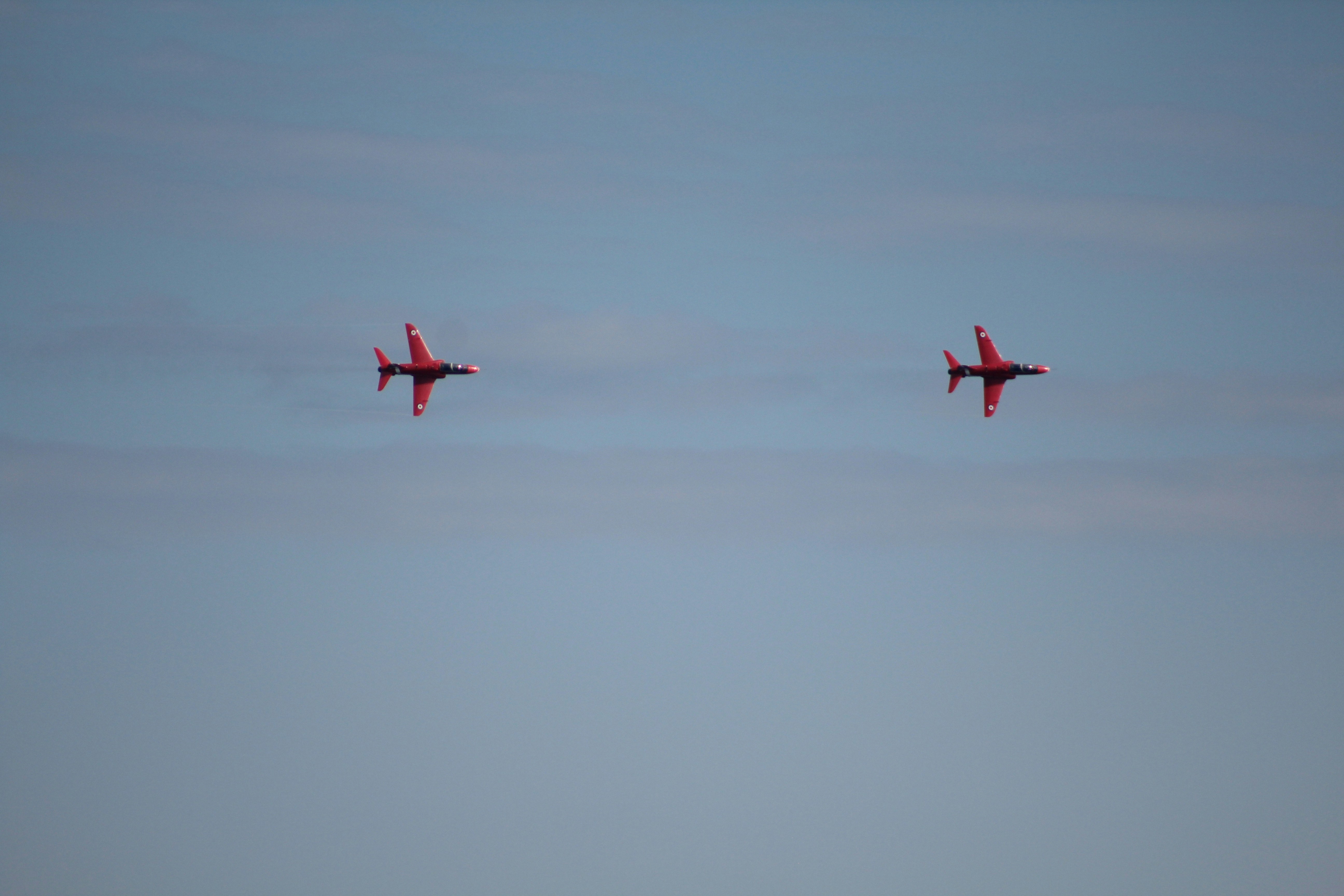 Two red airplanes in the sky photo – Free Red arrows Image on Unsplash