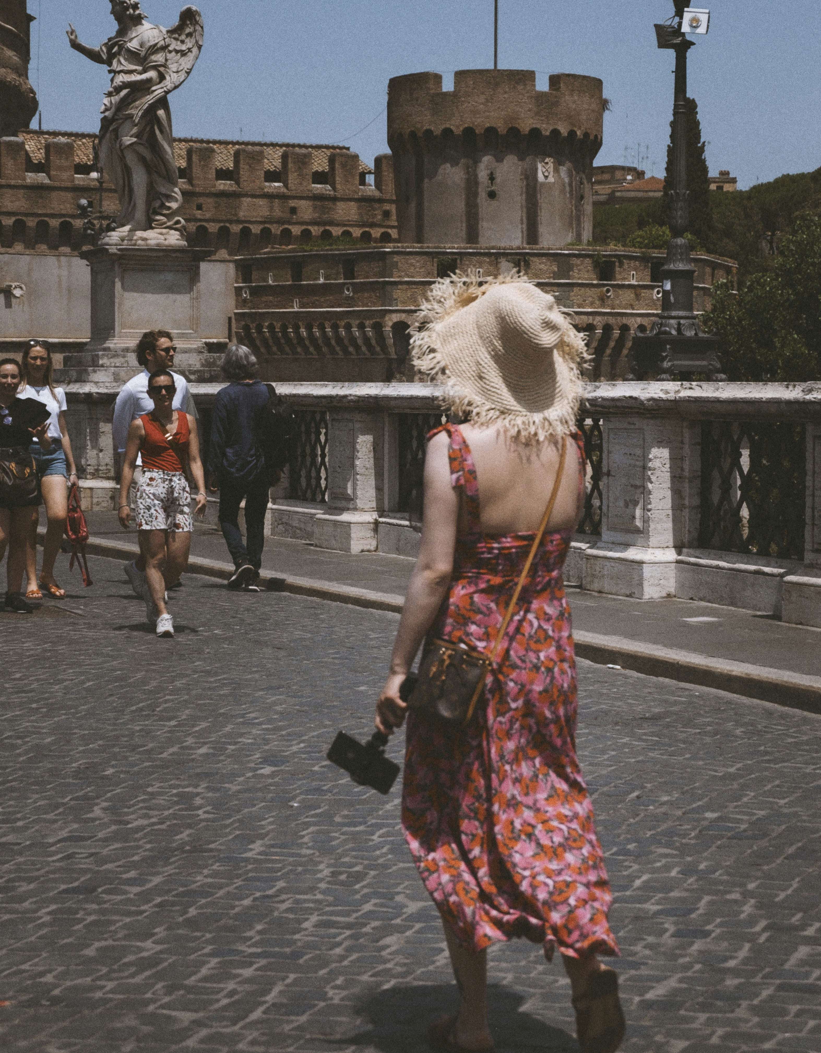 Romance on Stone: Florals and a Wide-Brim Moment on Rome's Bridge