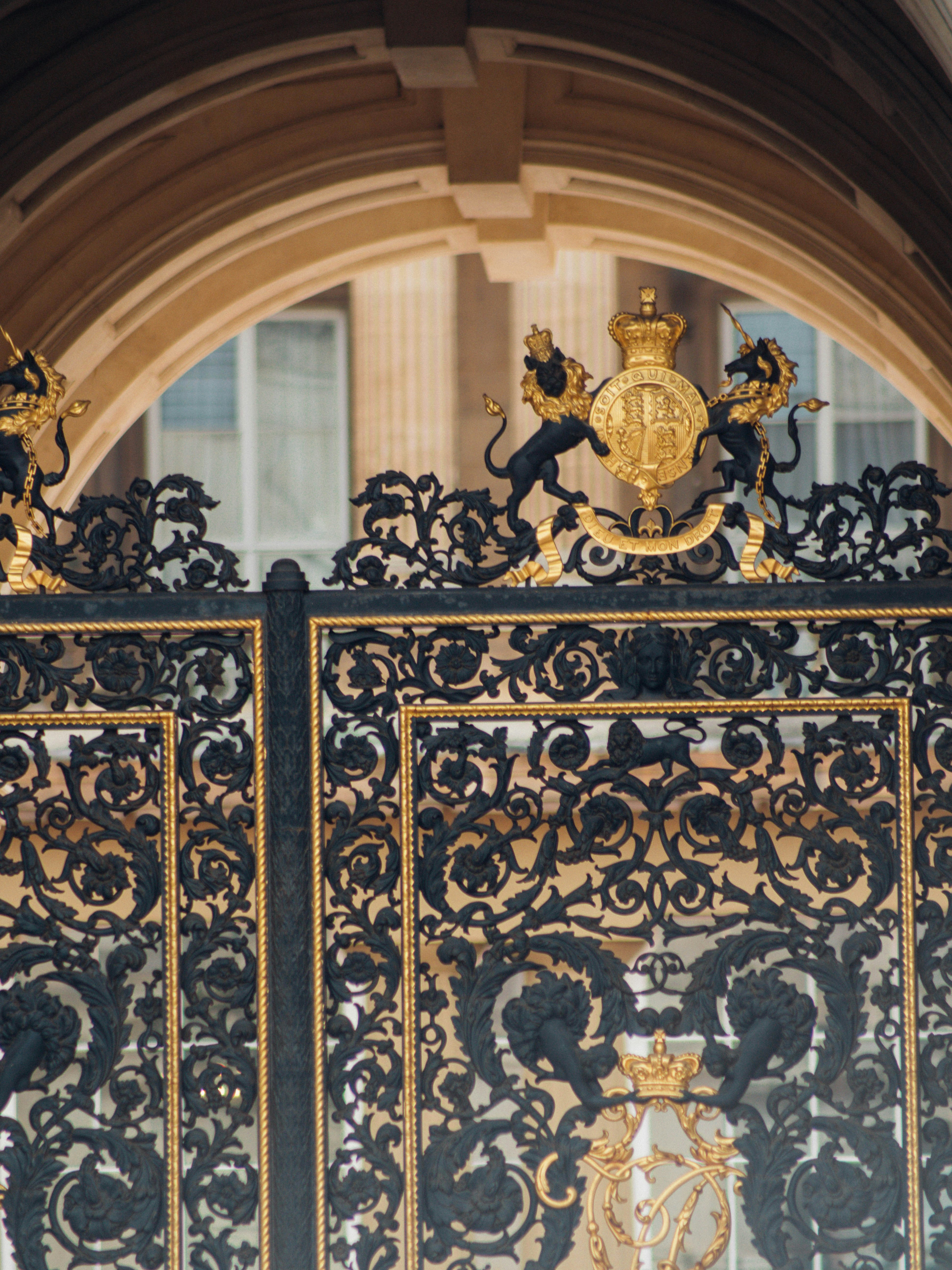 a metal gate with a gold and black design