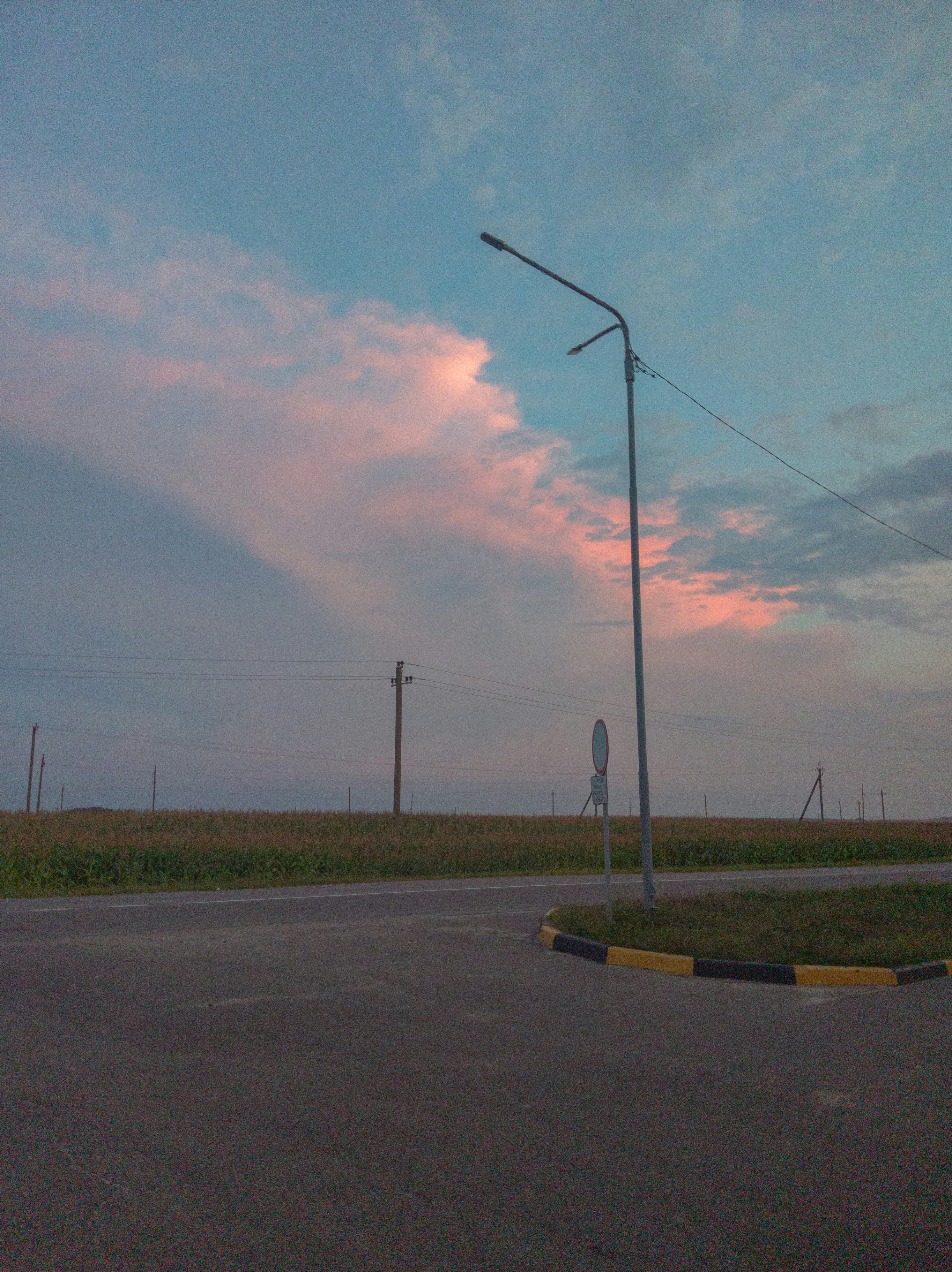 Lone Streetlight Against a Prairie Sunset