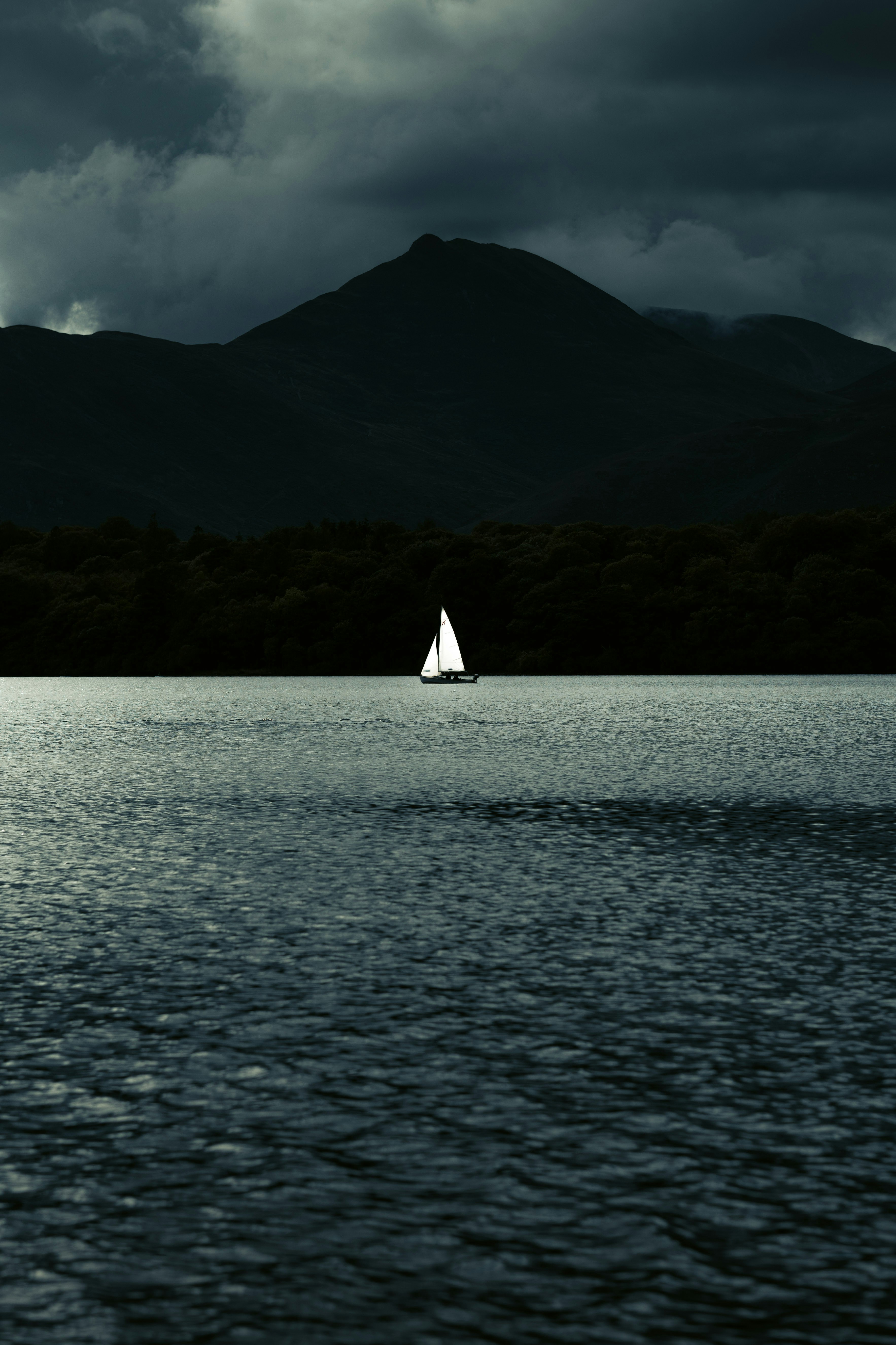 Lone Sail in a Dusk-Quiet Fjord