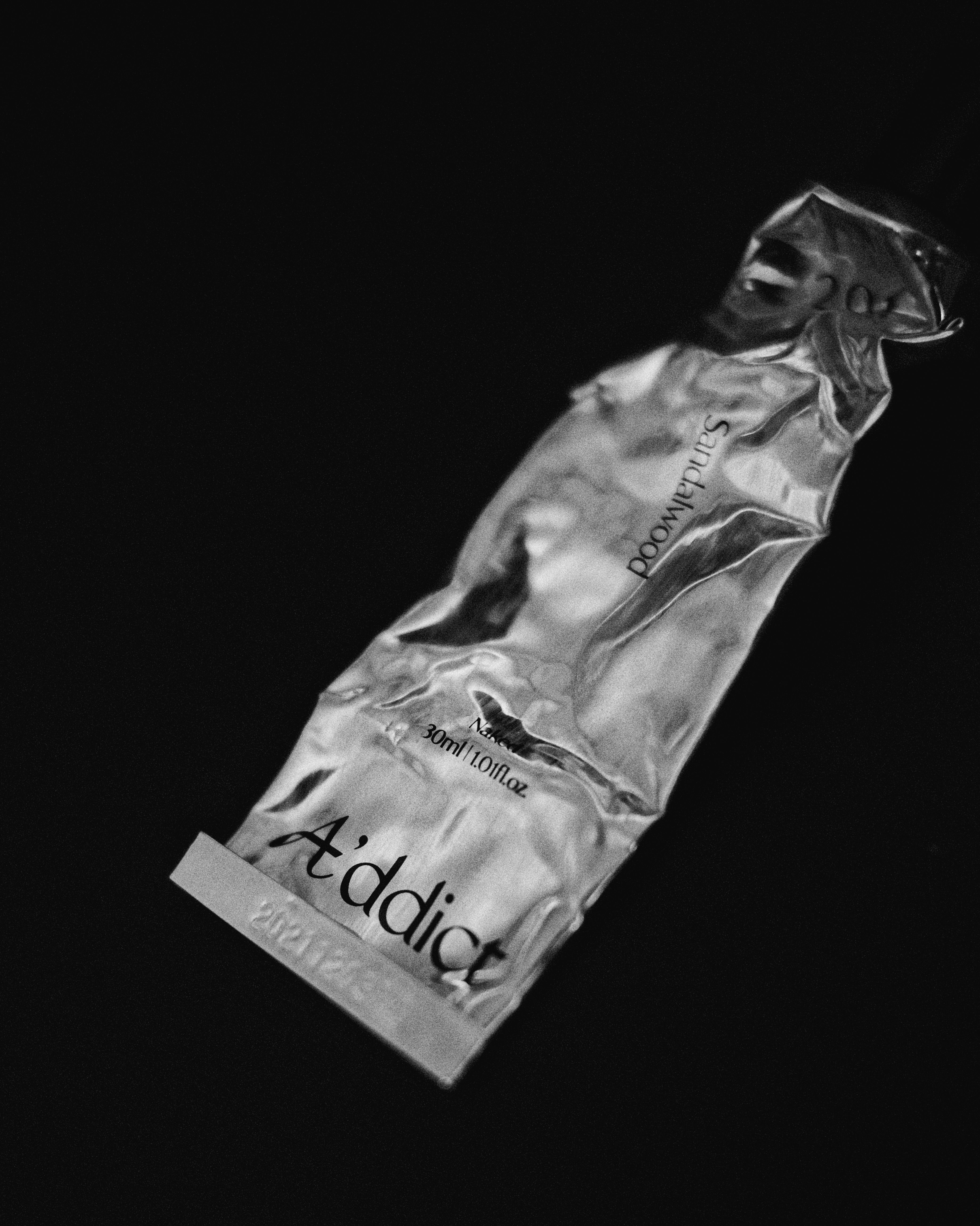 Crinkled Noir: Addict wrapper dissolves into shadow