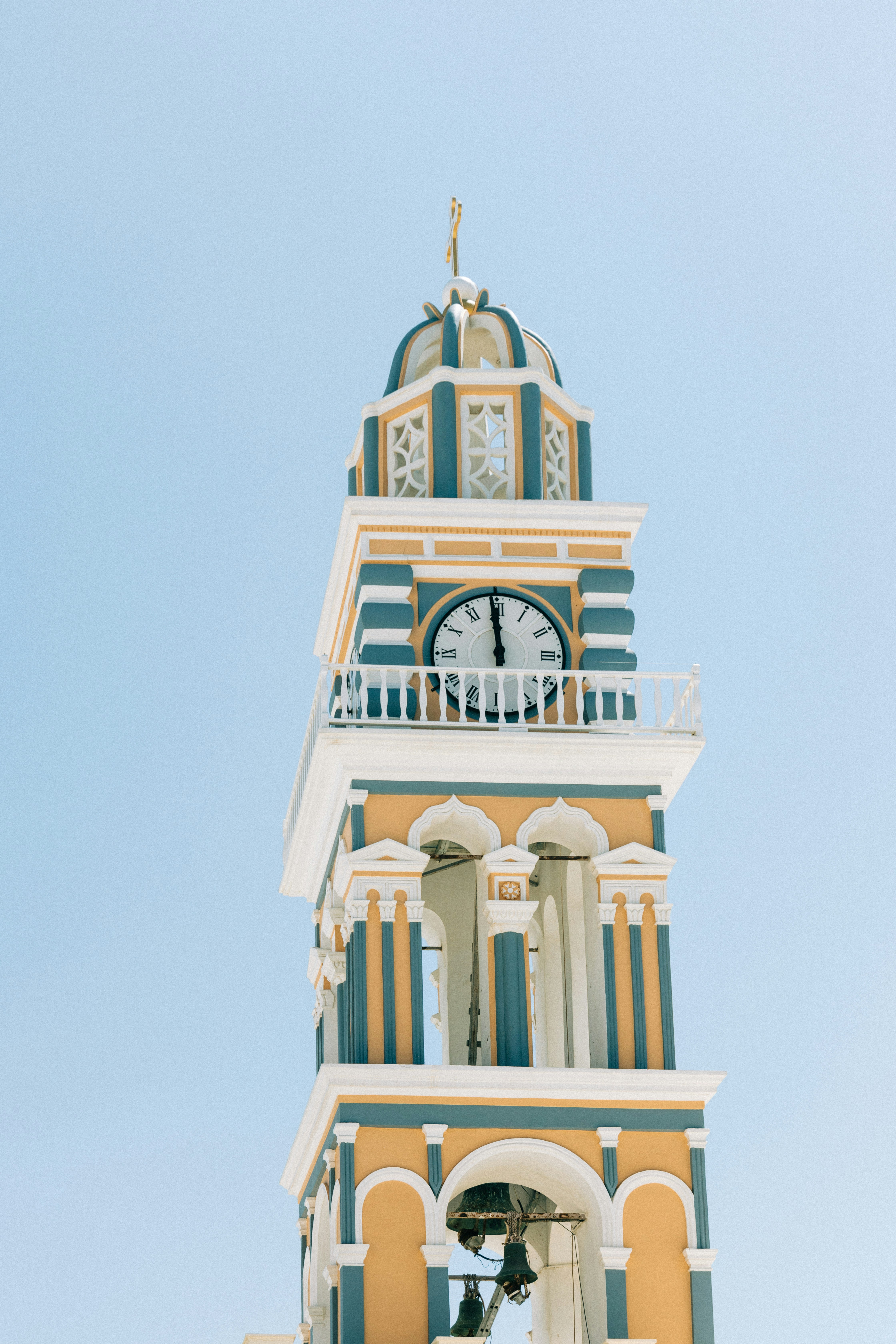 Pastel Clock Tower Rising Toward a Pristine Blue Sky