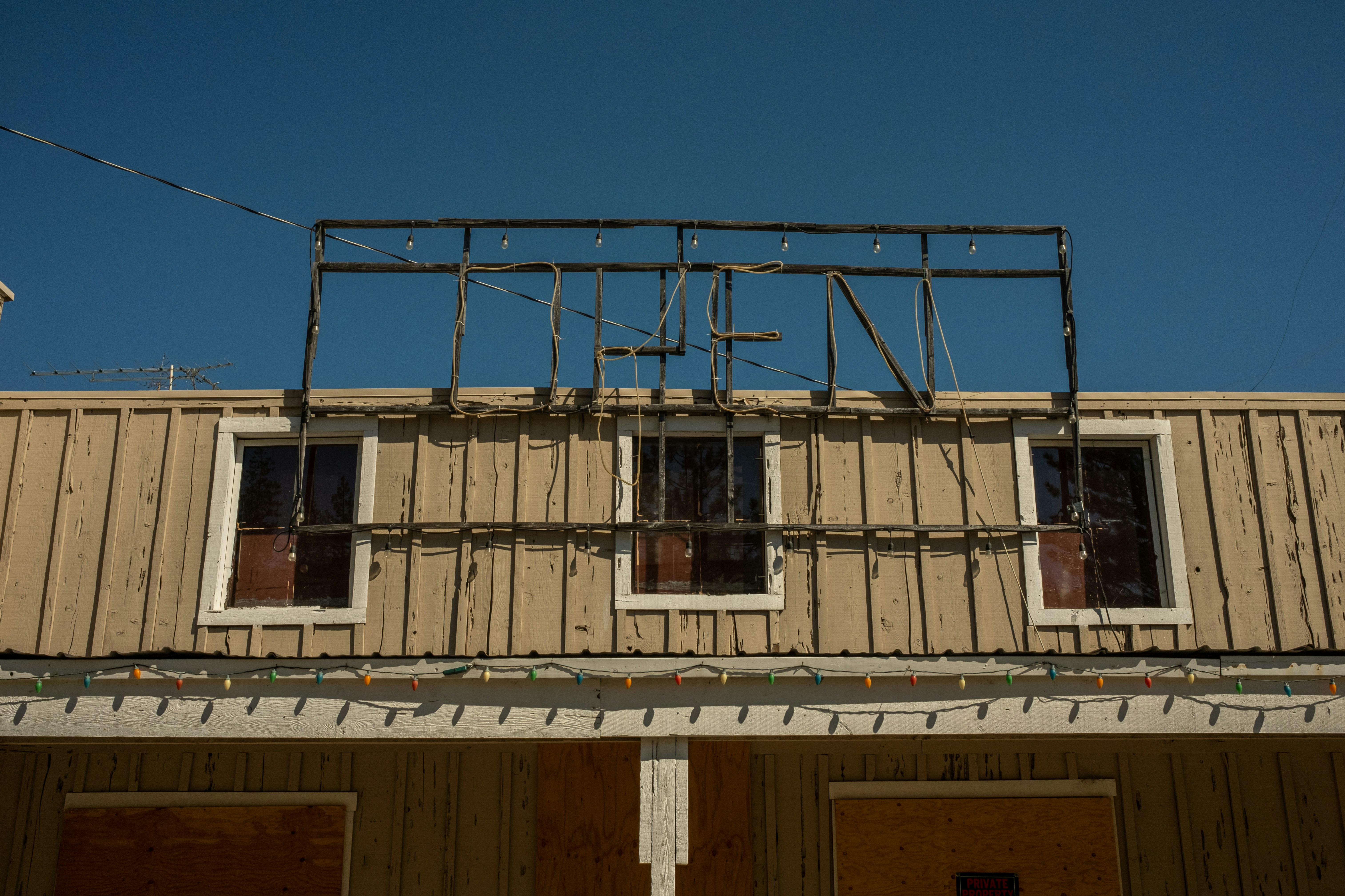 Open Frame Over a Weathered Storefront Under a Clear Blue Sky