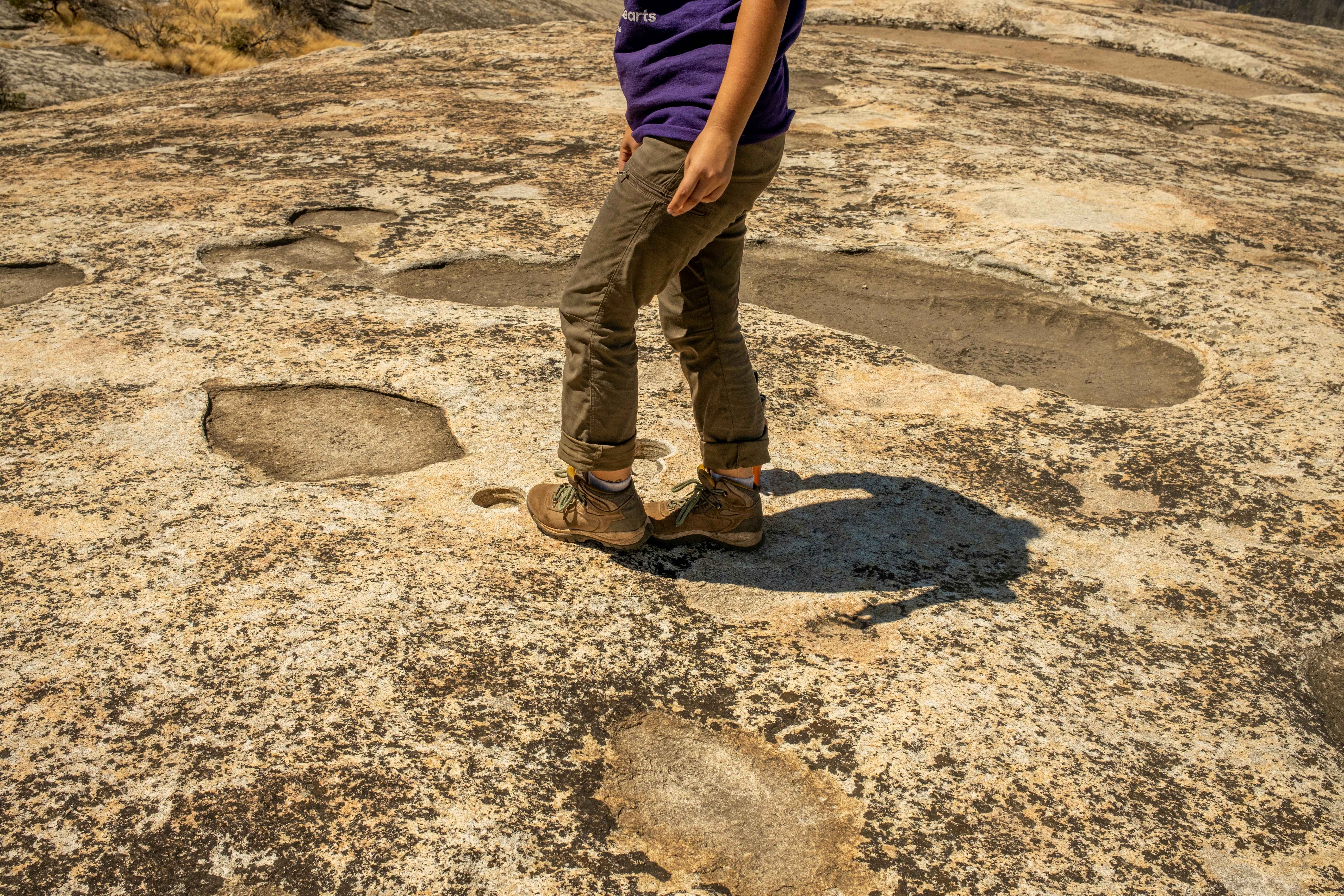Booted Steps Across a Pocked Granite Surface
