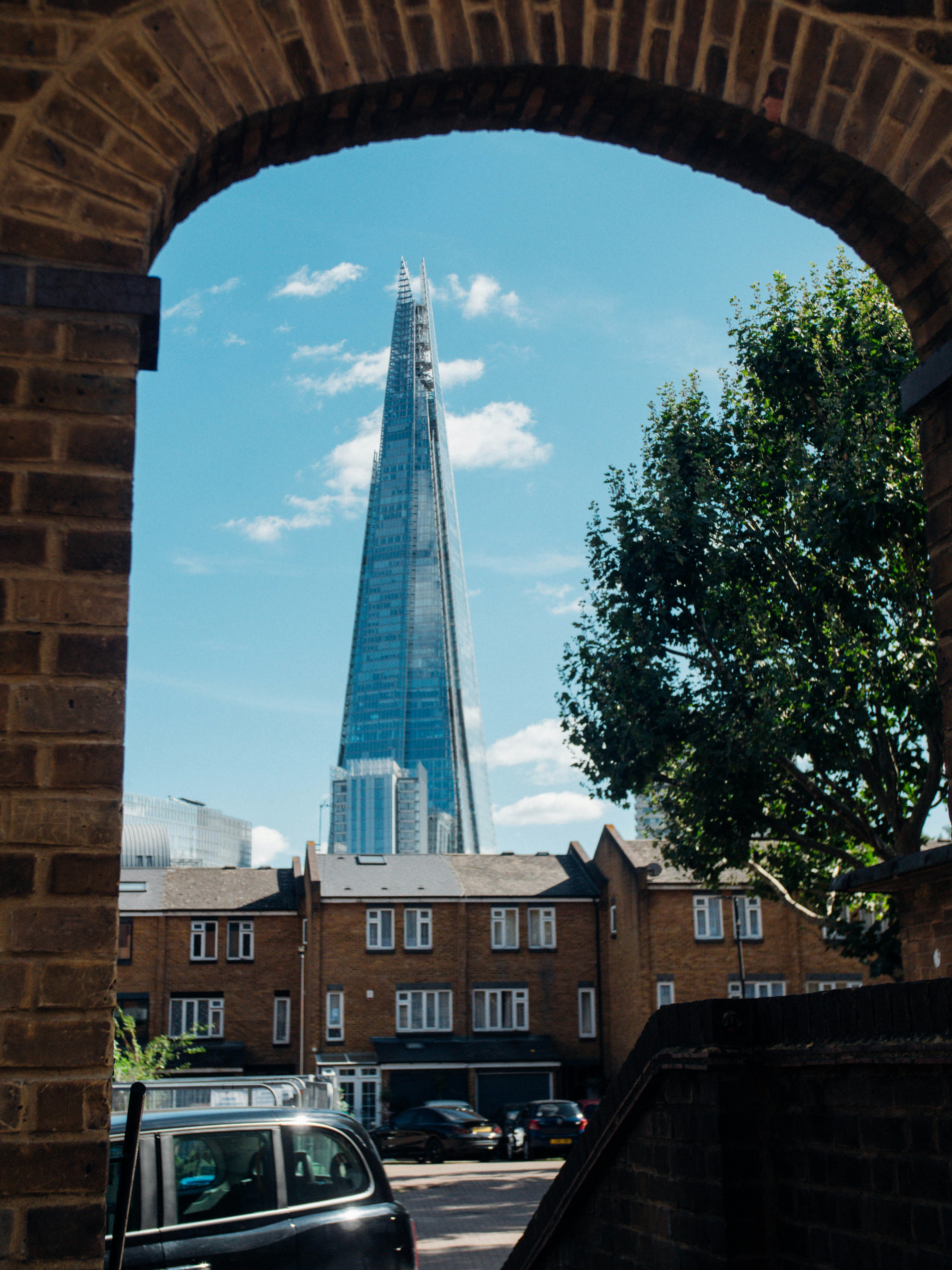 A view of a city through a window of a tall building photo – Free Blue ...