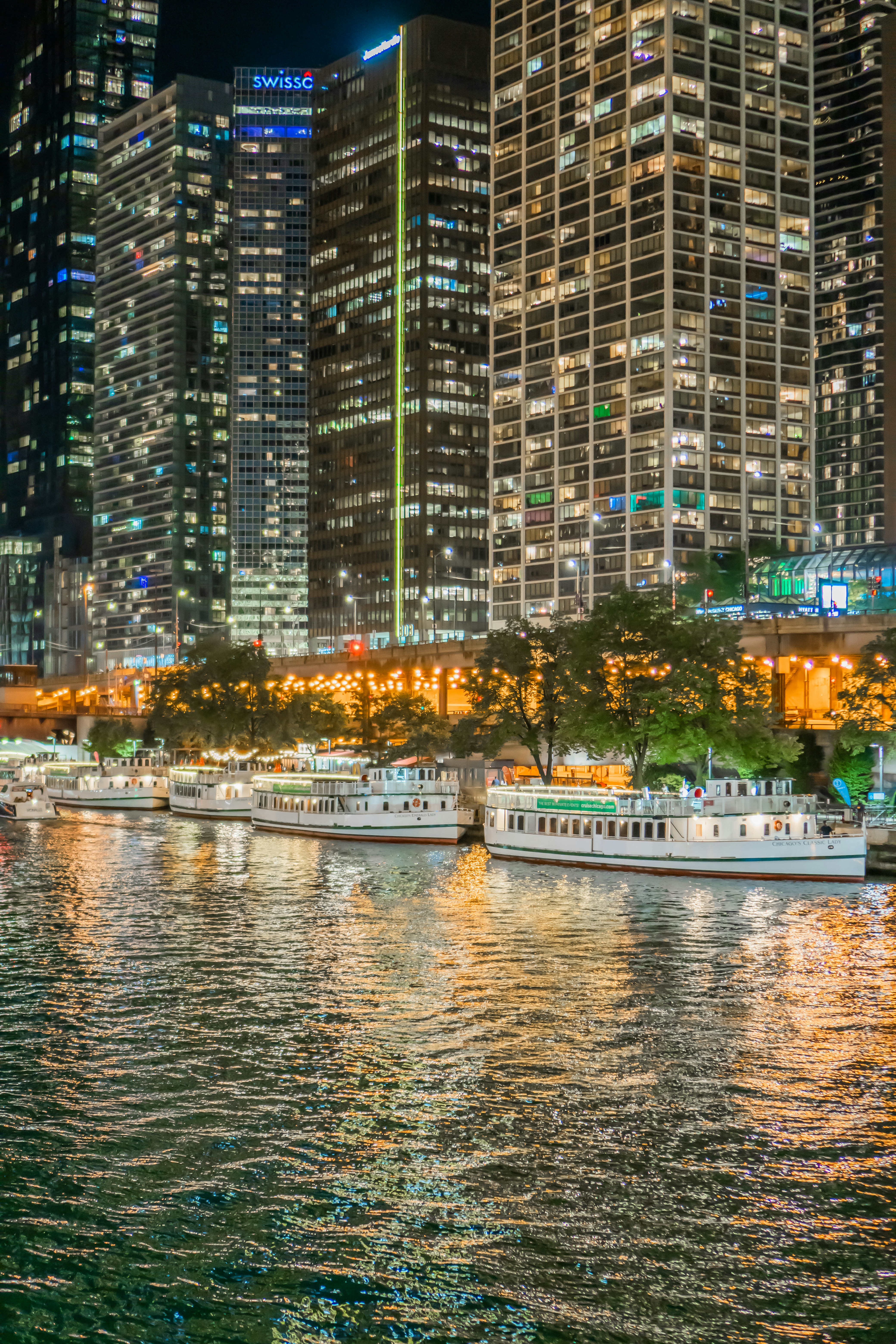 A river with boats in it and tall buildings around it photo – Free ...