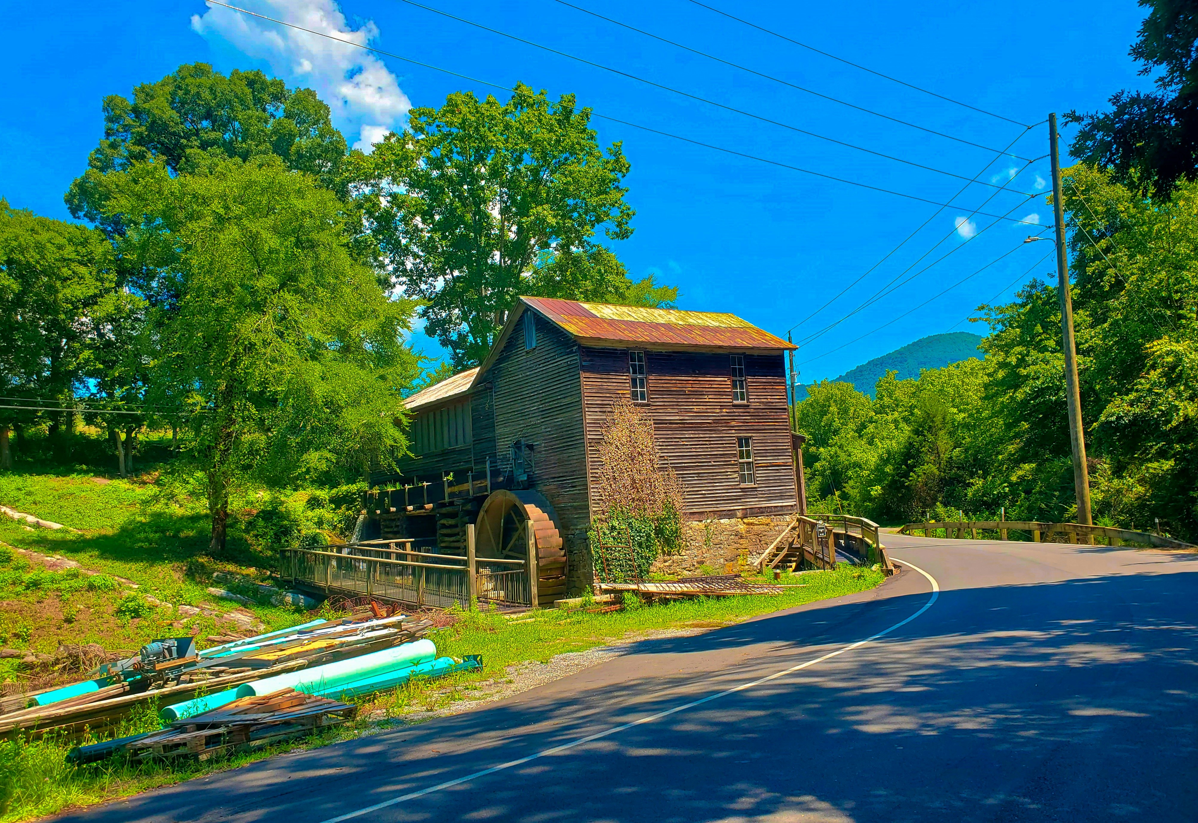 A brick building with a fence and trees around it photo – Free Great ...