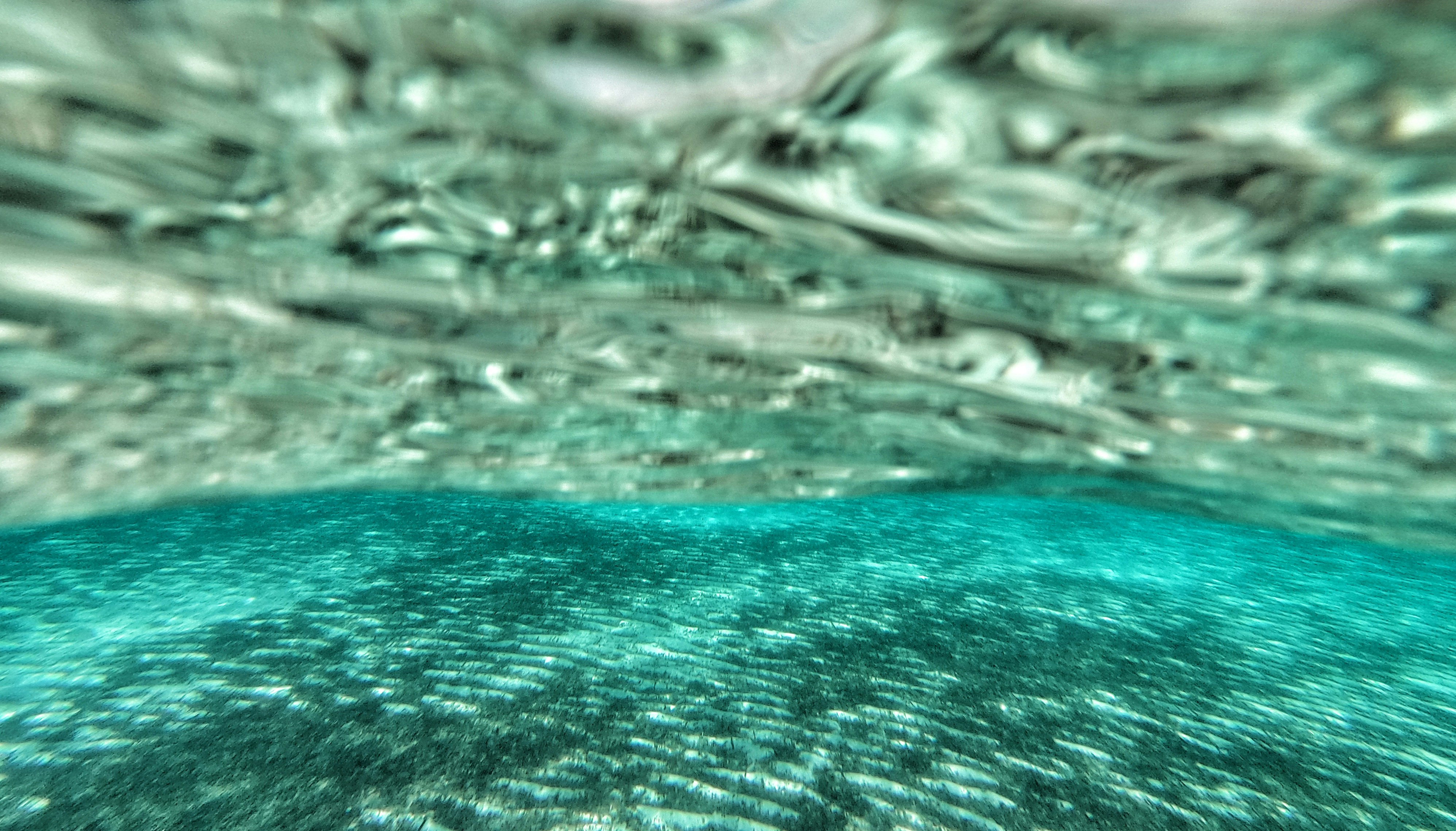 Turquoise Seabed Whisper: Light Ripples Beneath the Surface