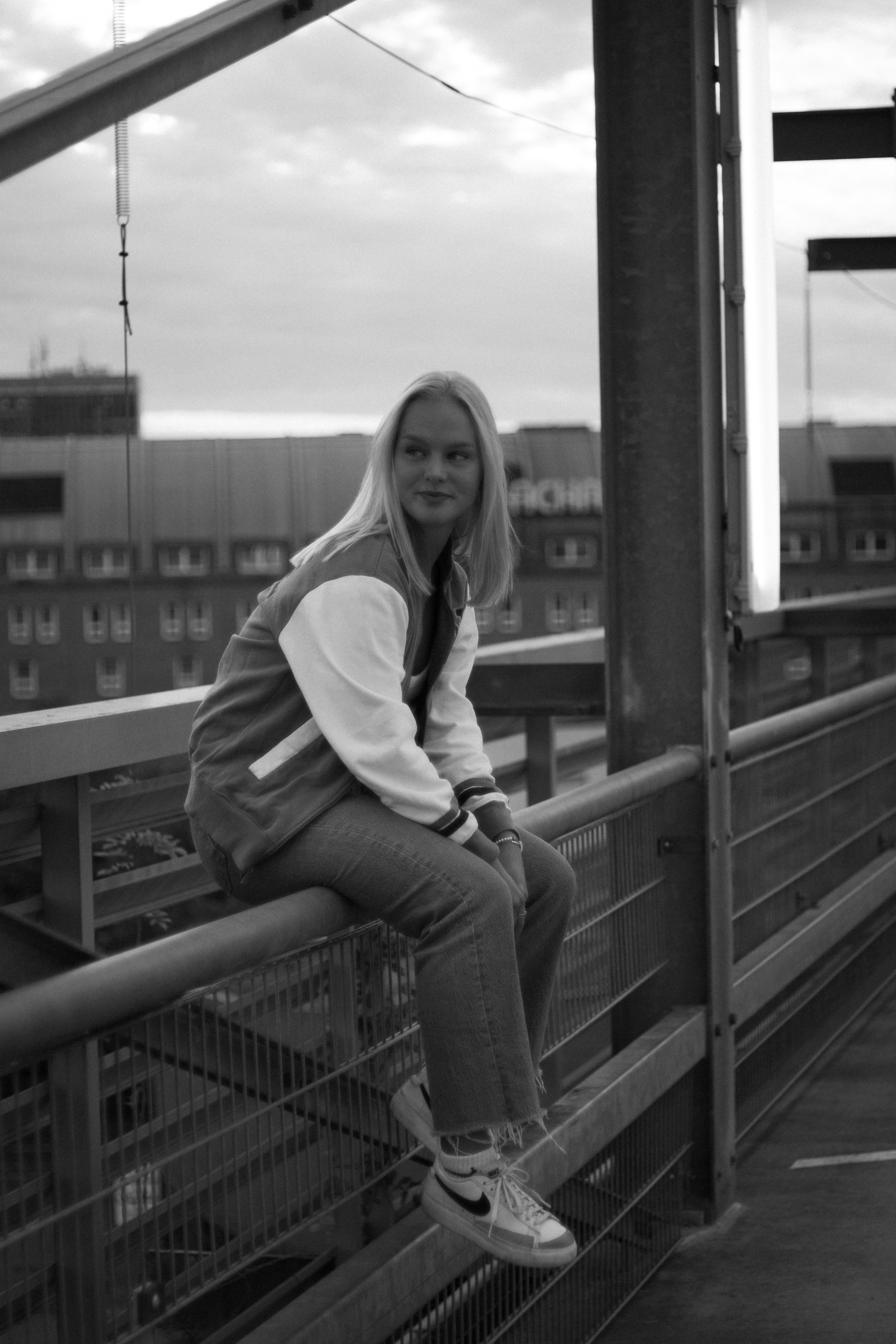 A person sitting on a railing photo – Free Handrail Image on Unsplash