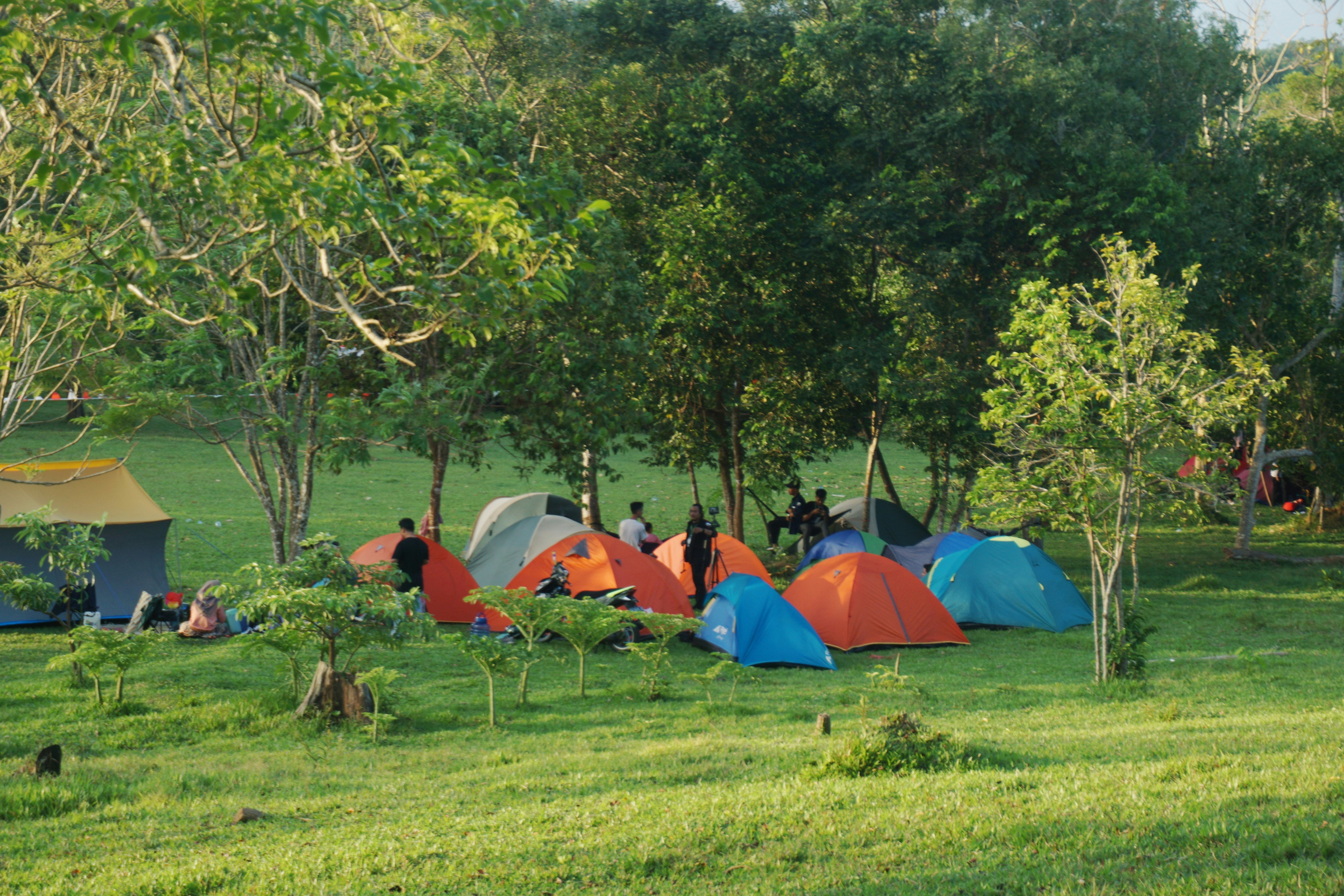 A group of people in a field with tents photo – Free Taman permana ...