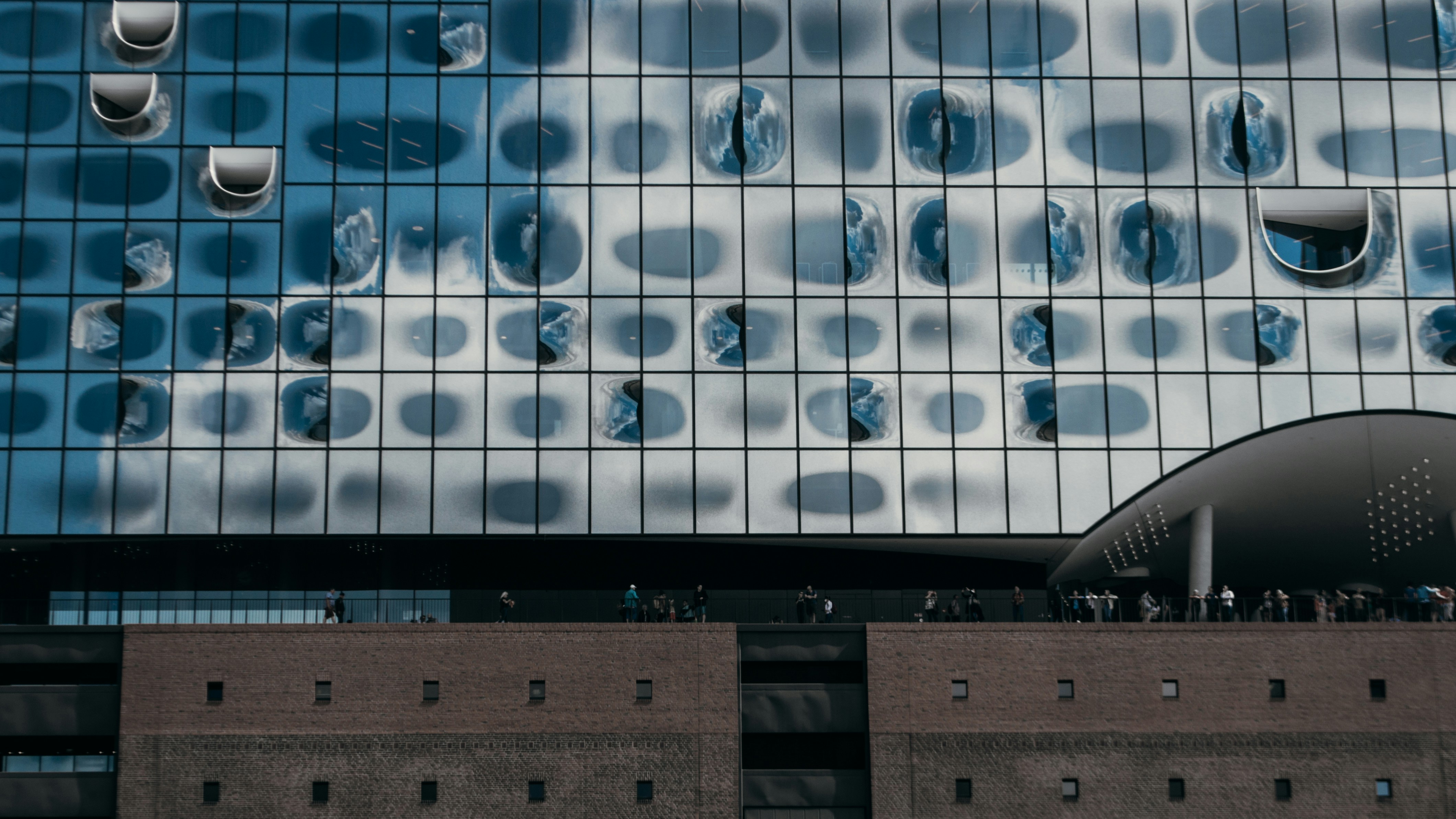 A large circular building with a large glass wall photo – Free Building ...