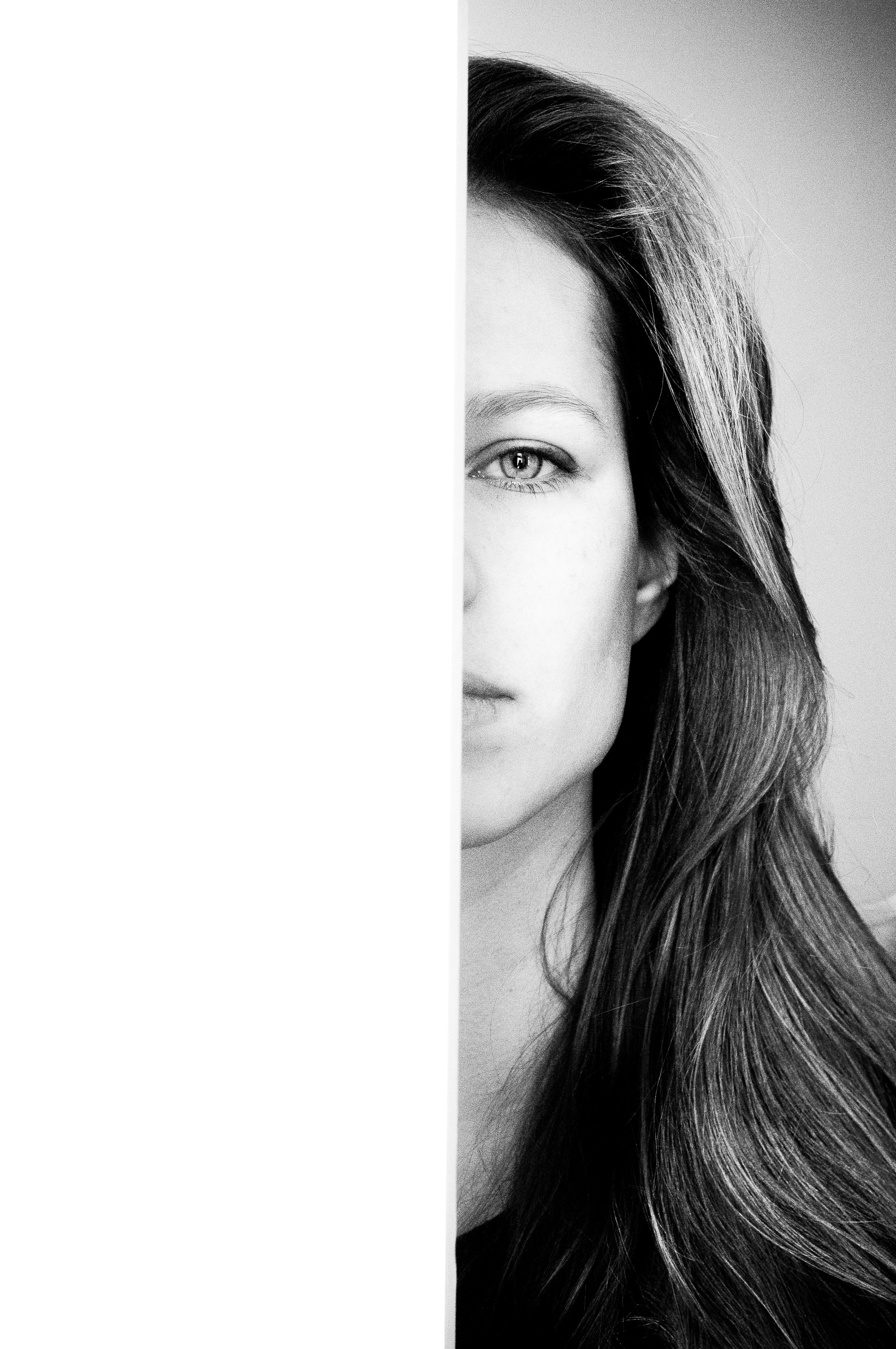 Glimpse Through a Quiet Divide: Half-Face Portrait in Monochrome
