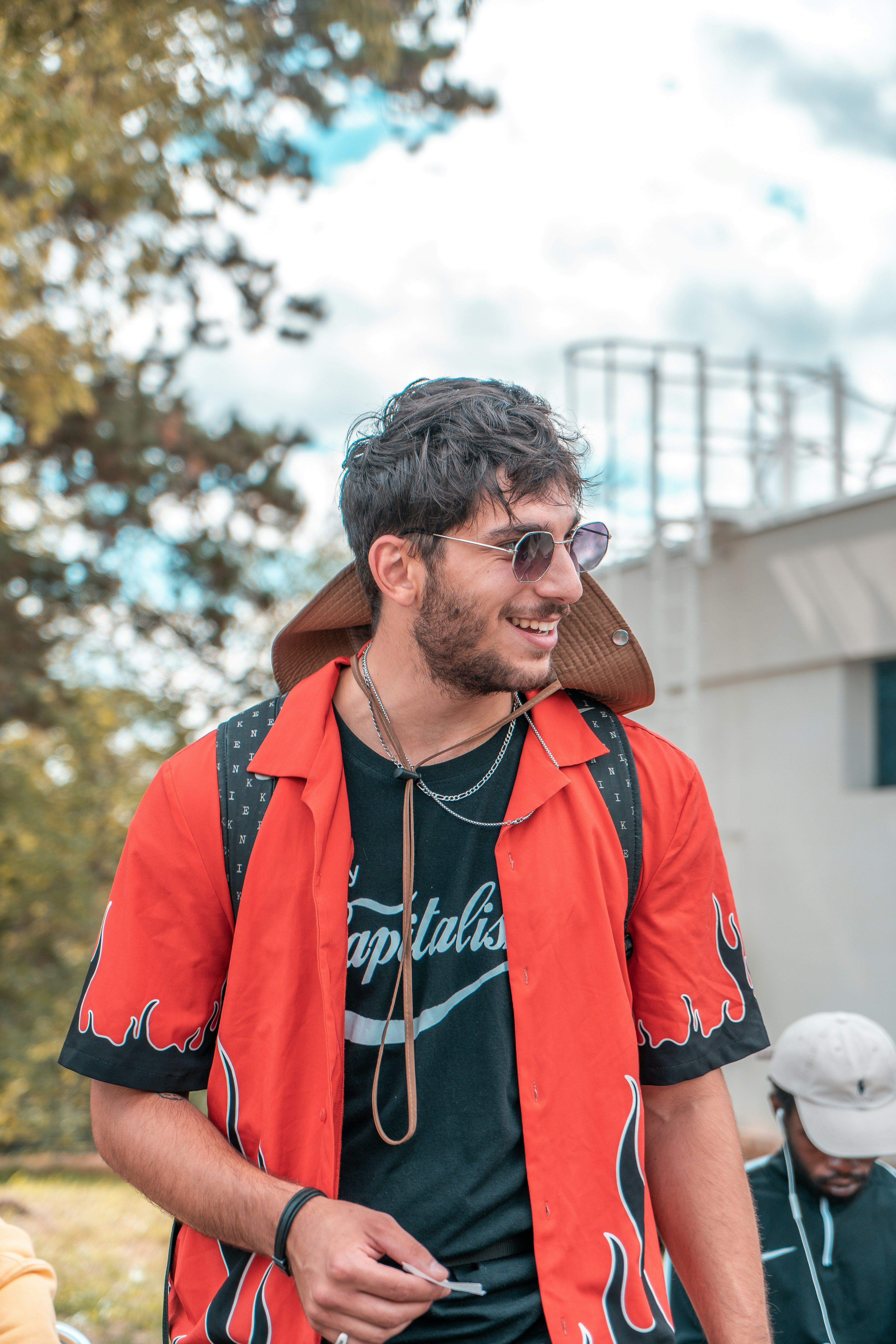 Flame-Print StreetStyle: a sunlit candid of a bearded traveler