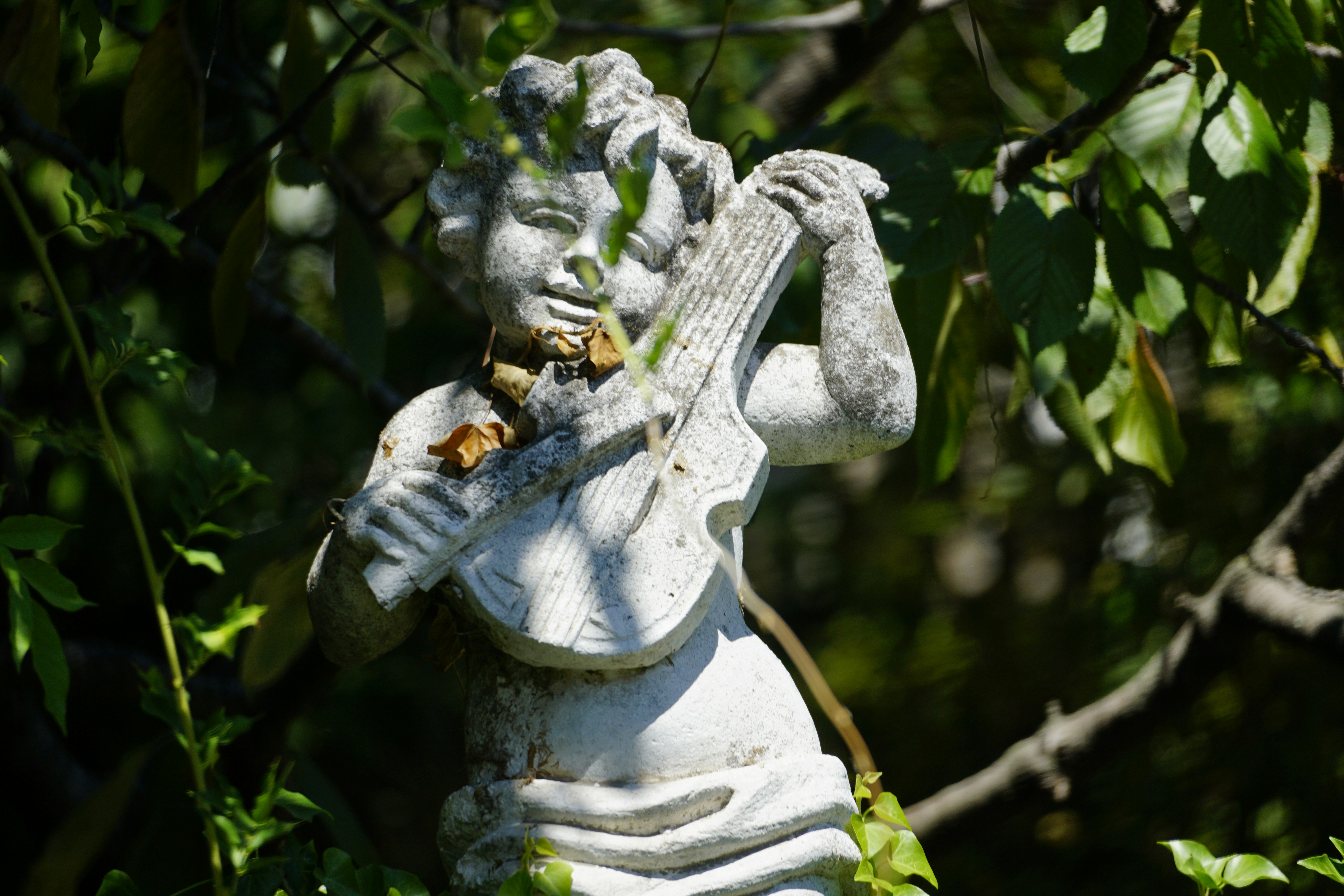 a statue of a person holding a cross