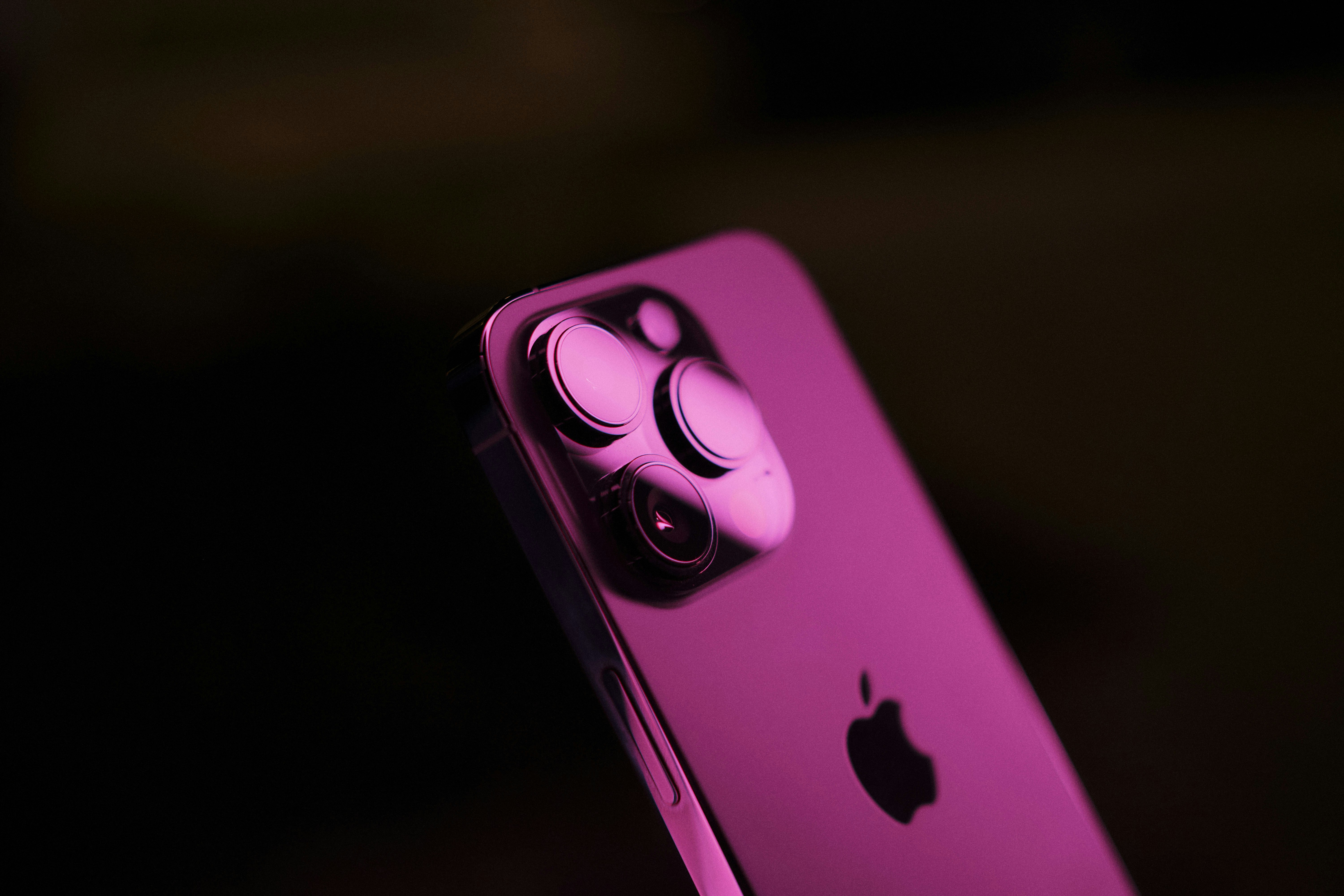 Magenta Glow on a Premier Chip: A Proximity Shot of the iPhone’s Triple-Lens Tail