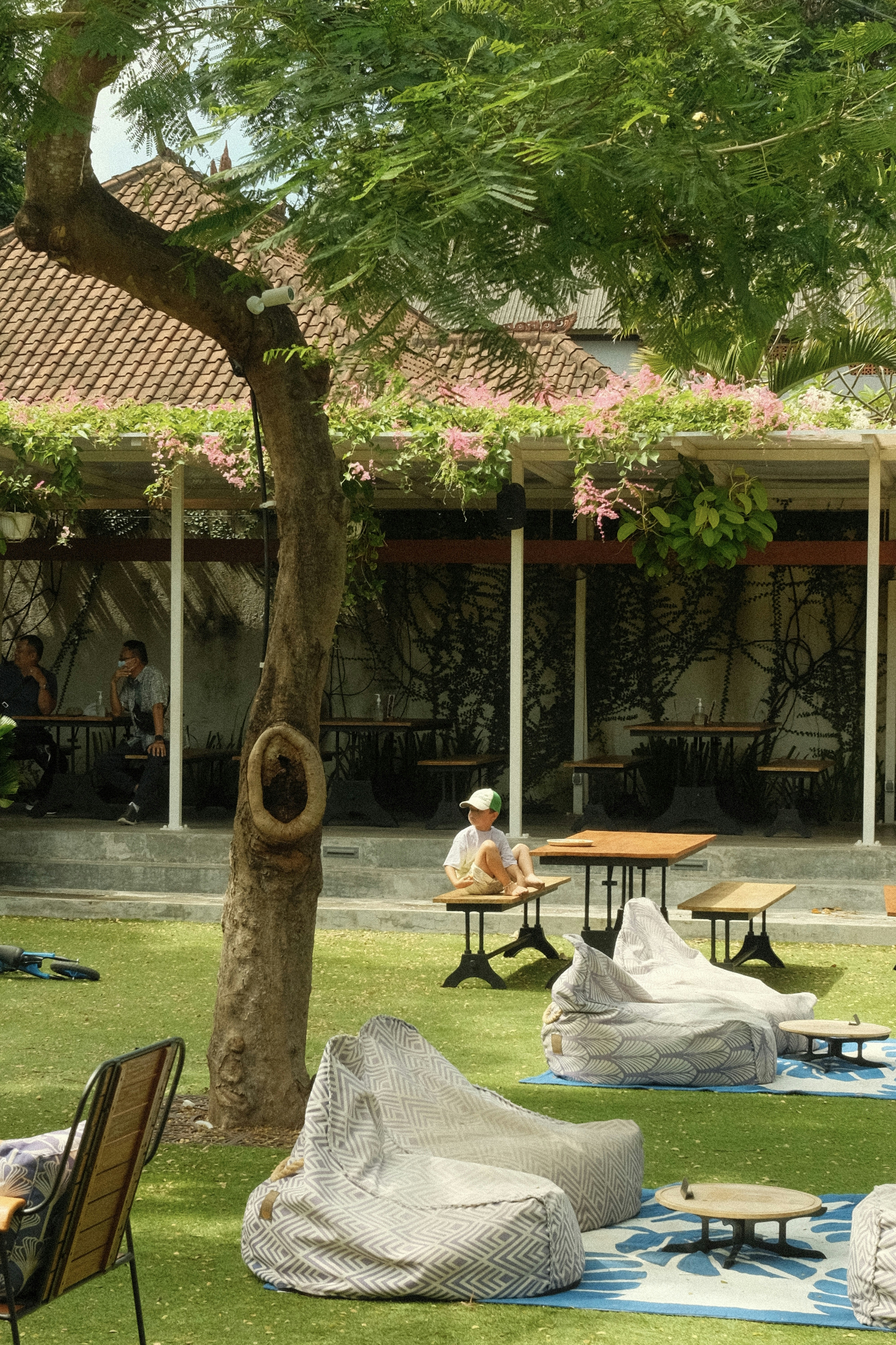 Under the Canopy: A Child at a Sunlit Garden Café