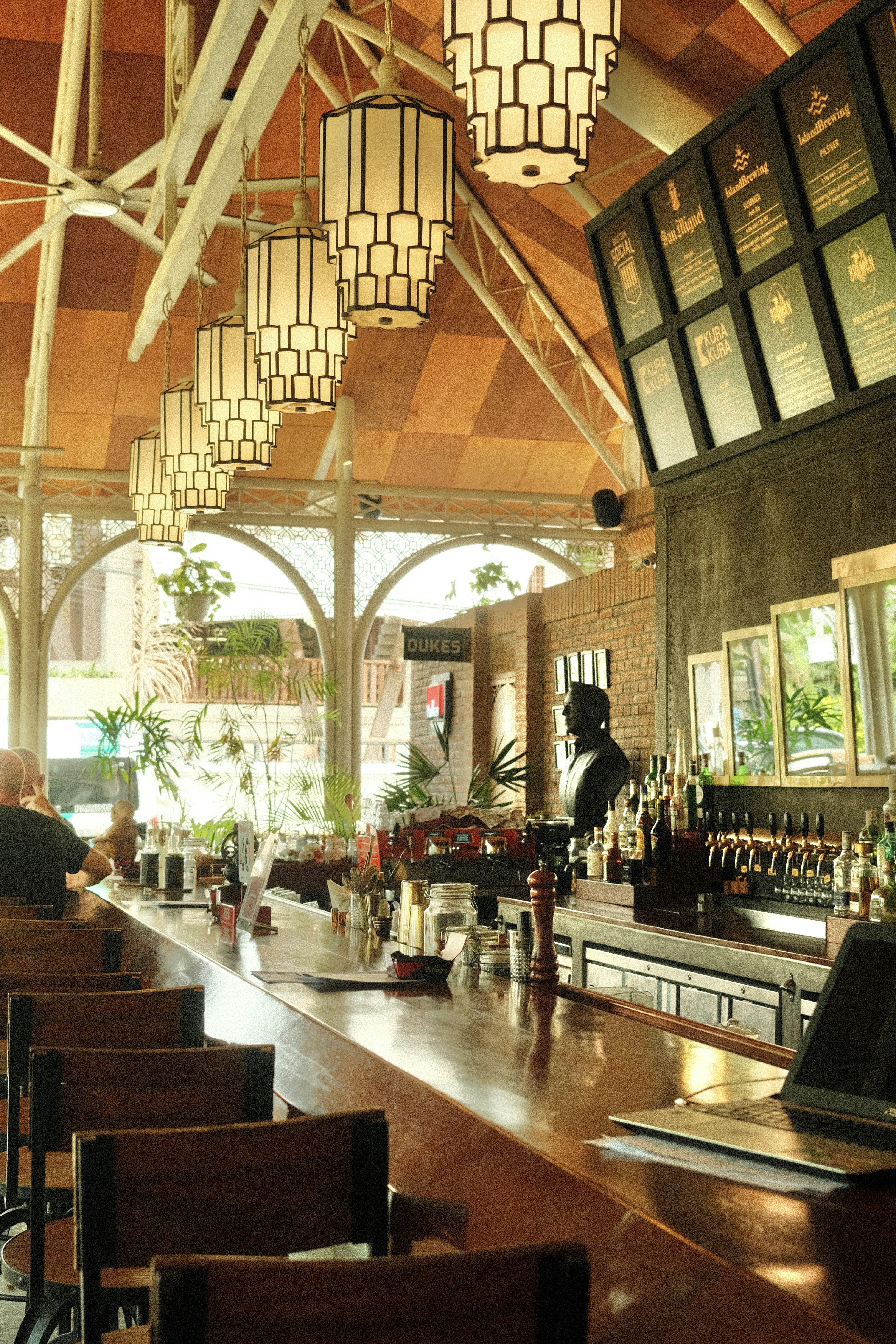 a restaurant with a large chandelier and a laptop