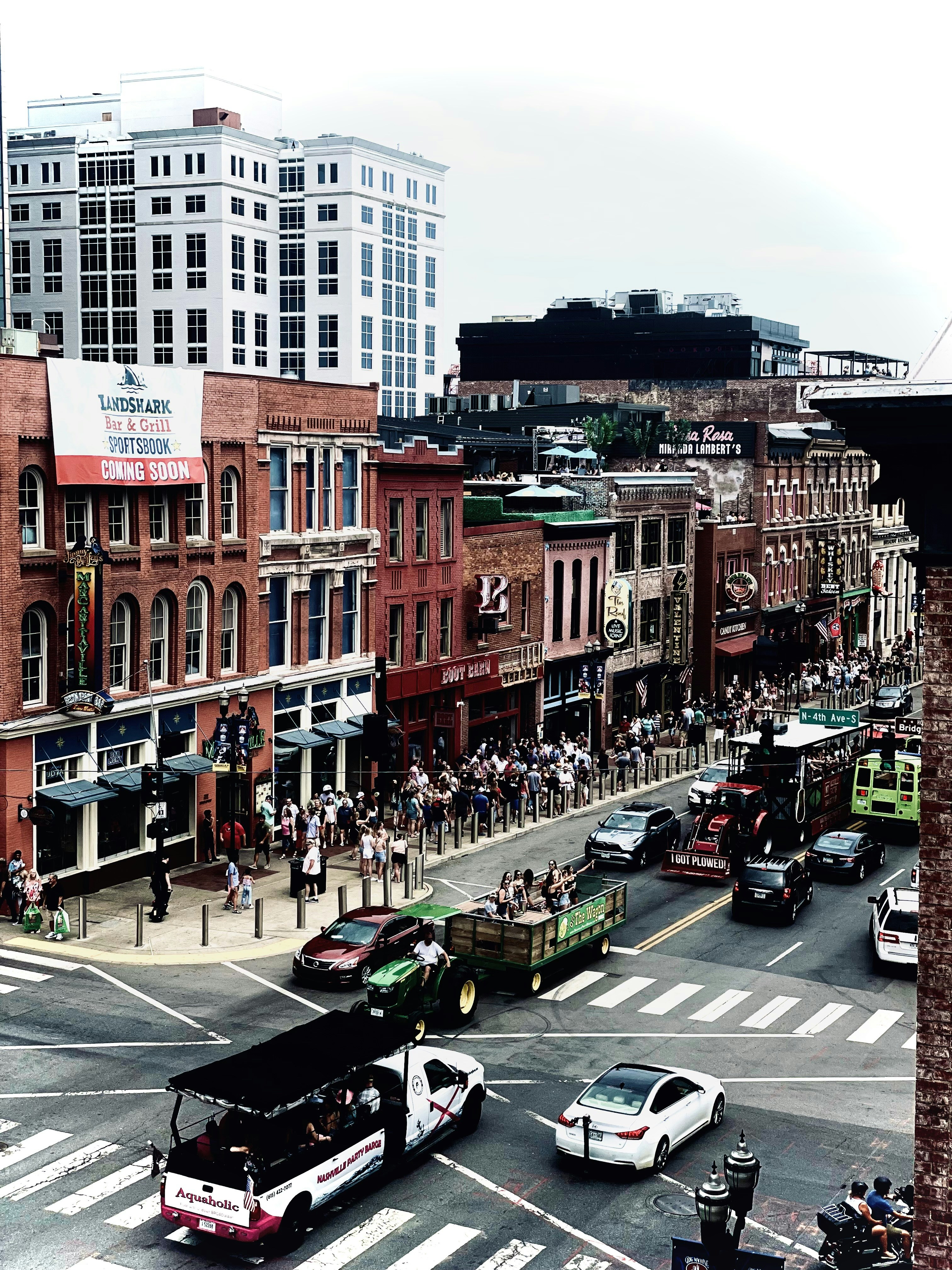Overhead Street Pulse: Crowds, Brick Facades, and City Motion
