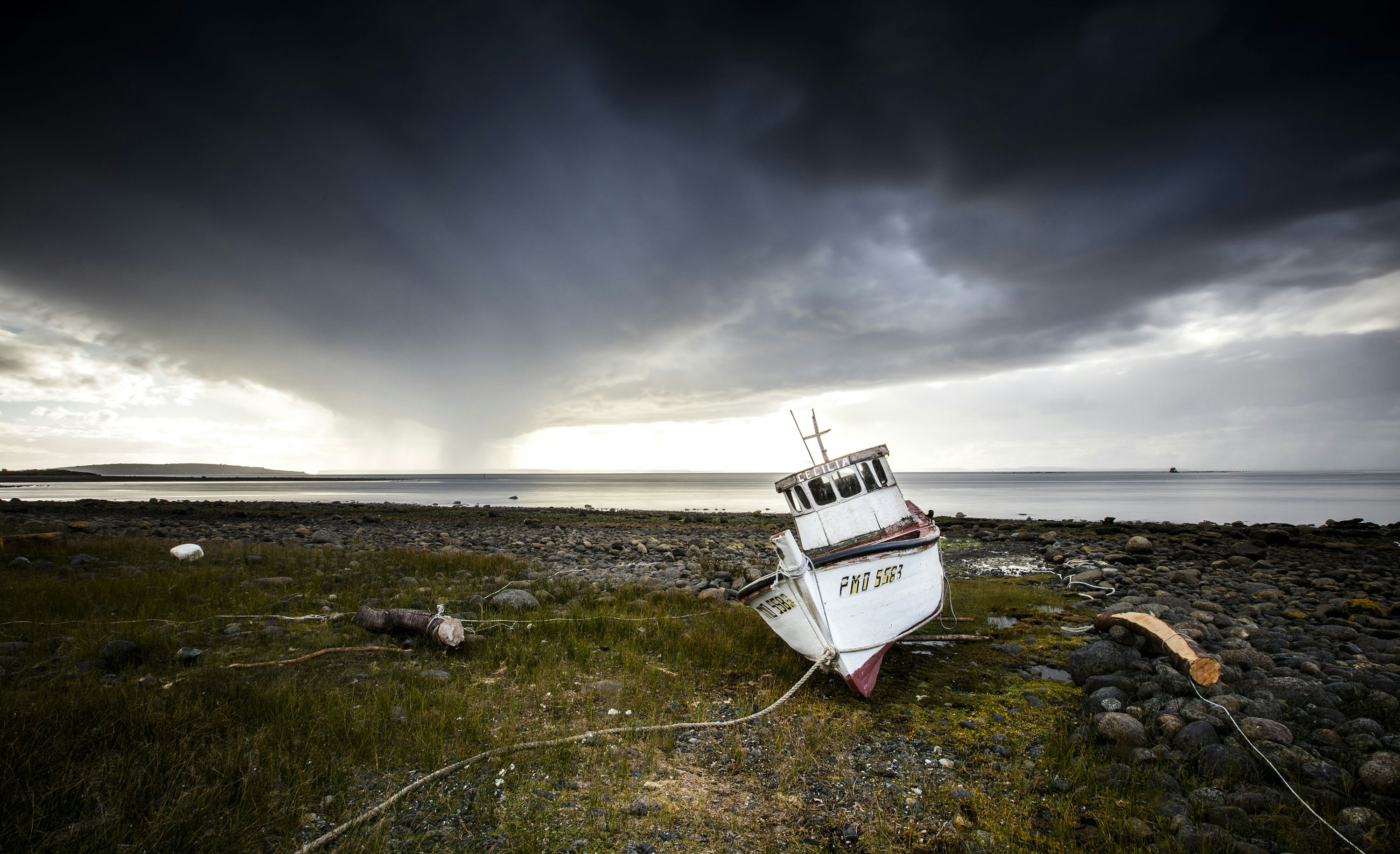 A beached ship in southern chile waits for a passing storm to sweep in