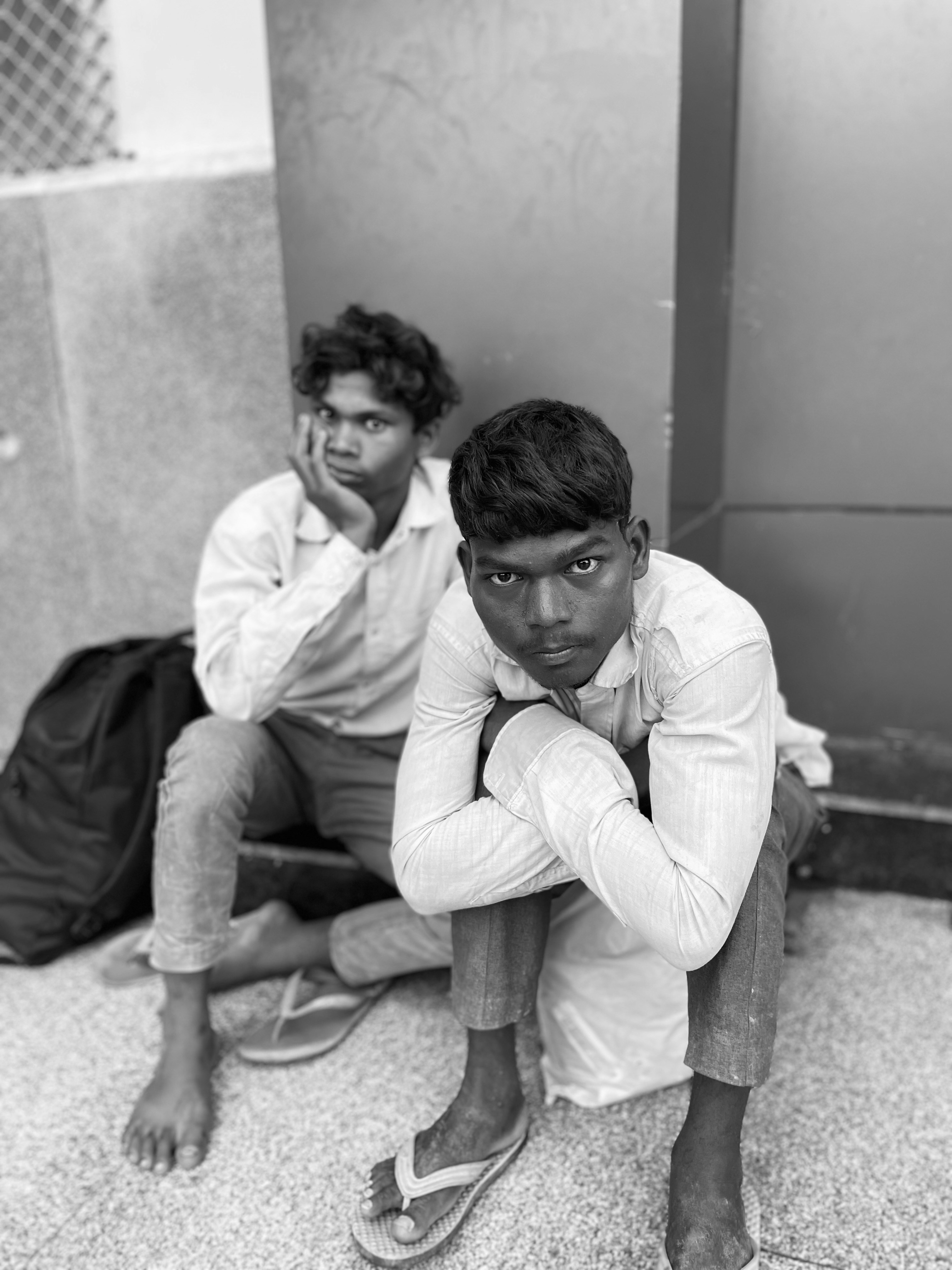 a couple of men sitting on the floor