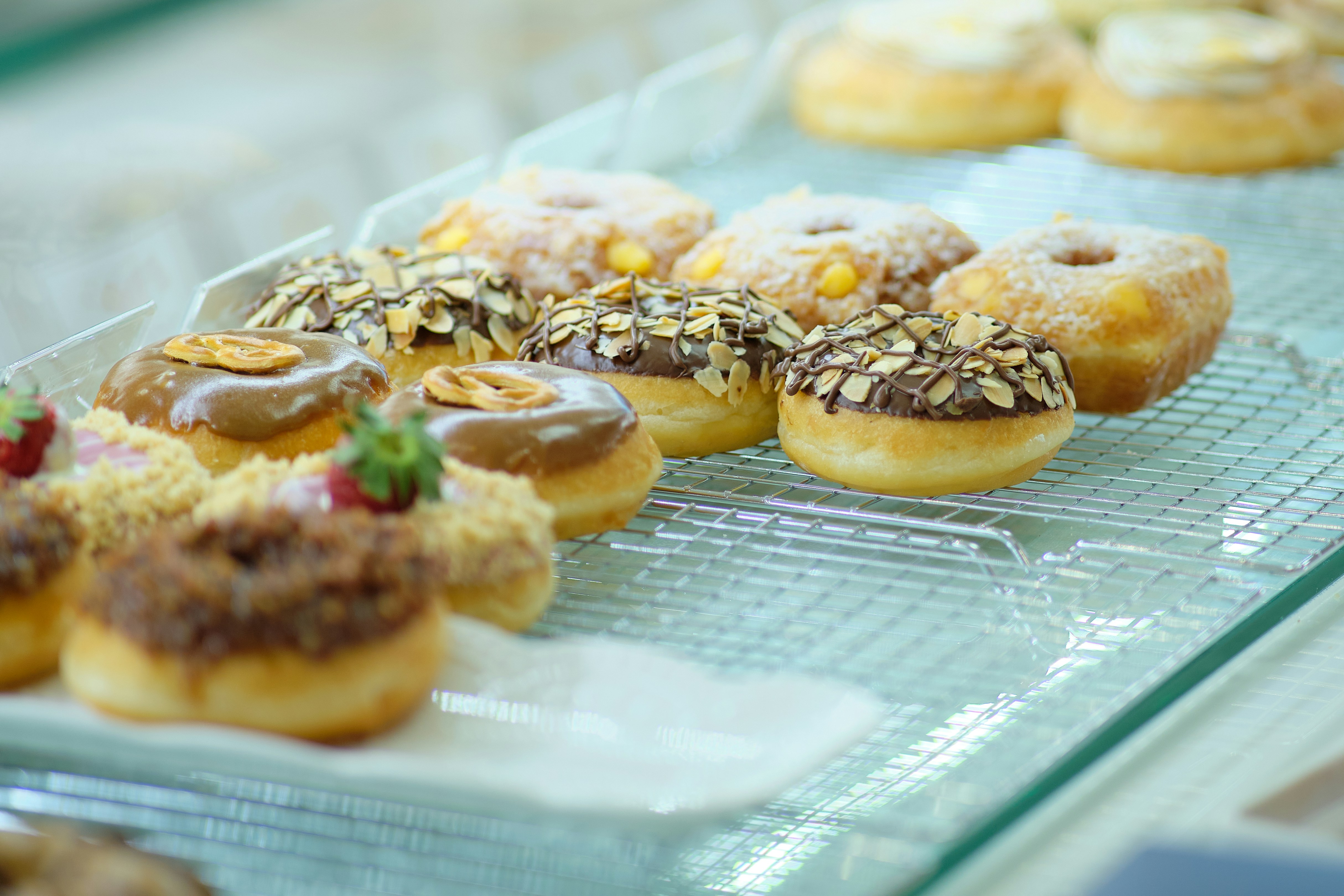 A group of pastries on a metal rack photo – Free John donut - the ...